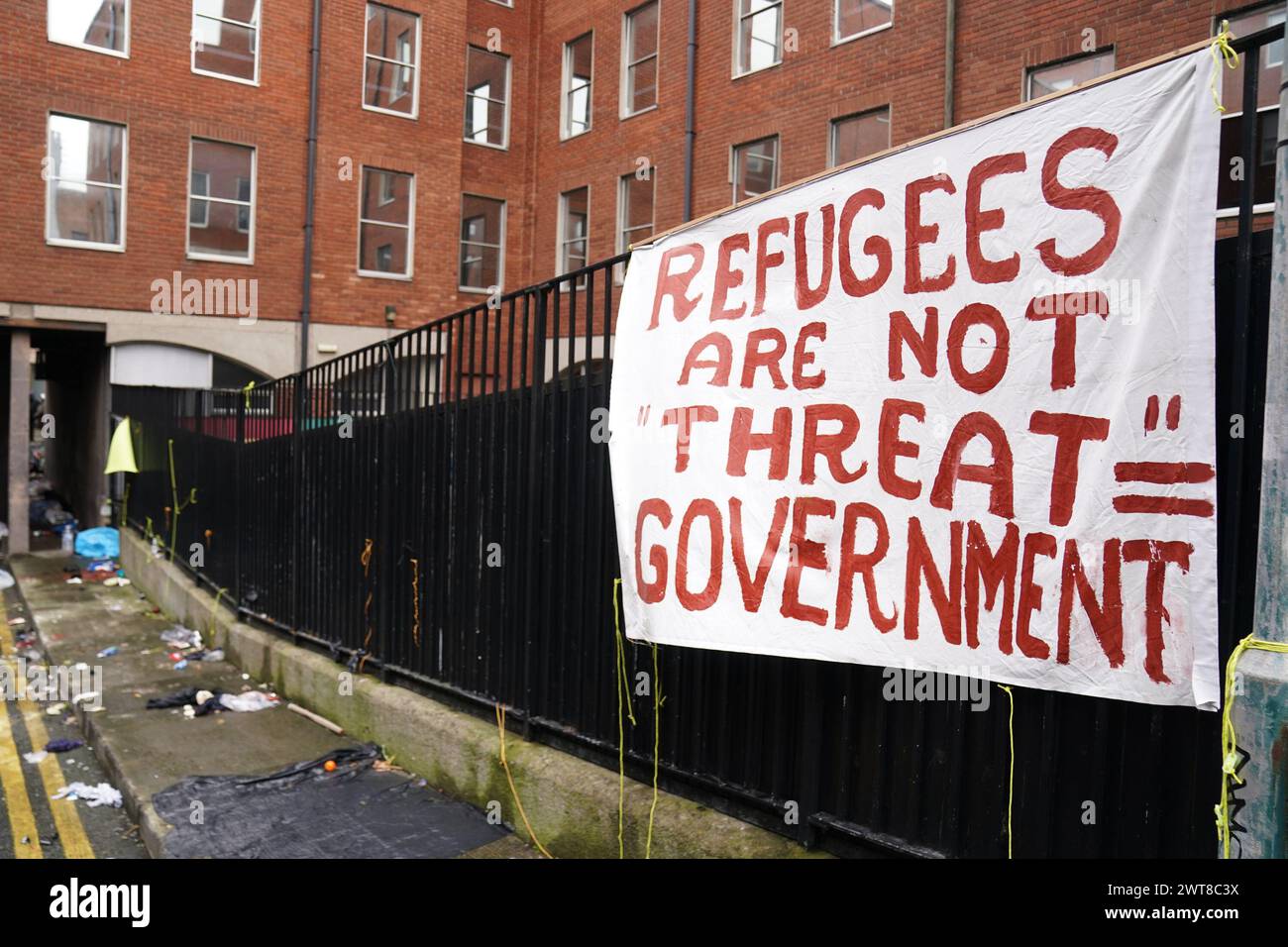 A banner at a site used by asylum seekers at the International ...