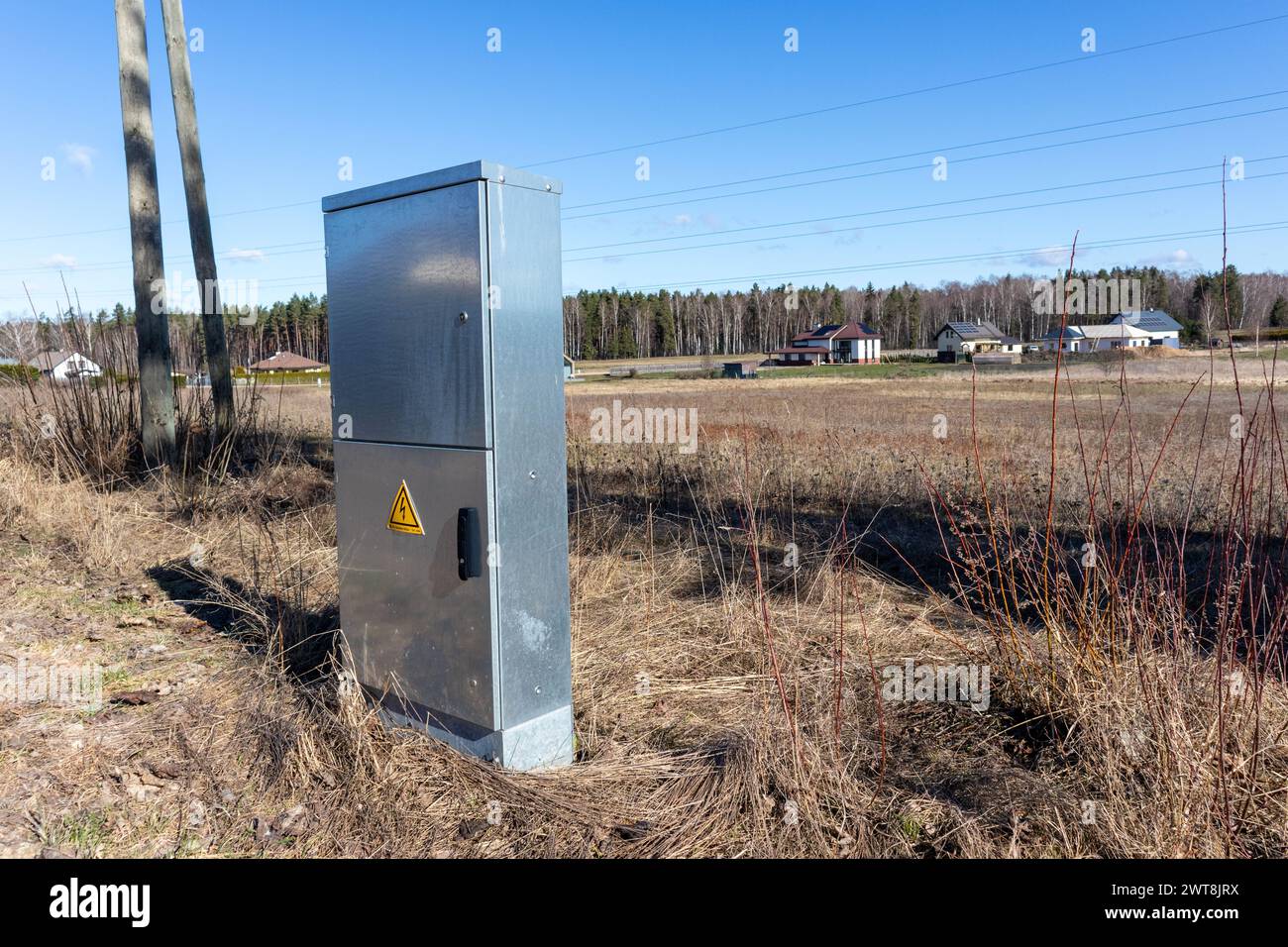 Metal electrical distribution box on field background Stock Photo - Alamy