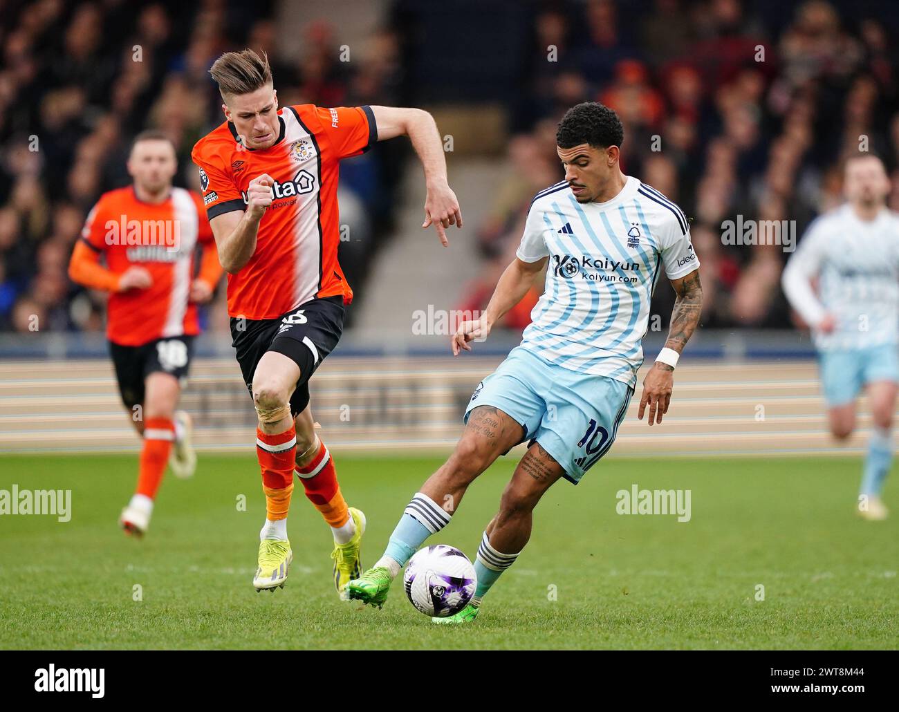 Luton Town's Reece Burke (left) and Nottingham Forest's Morgan Gibbs ...