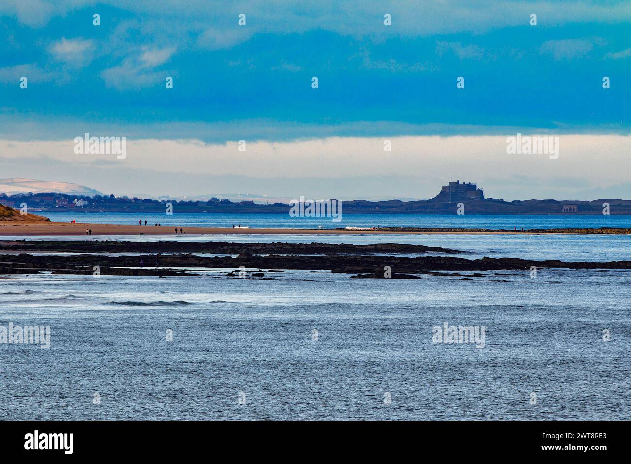 Bamborough Castle from the harbour at Aeahouses, in Northumberland ...