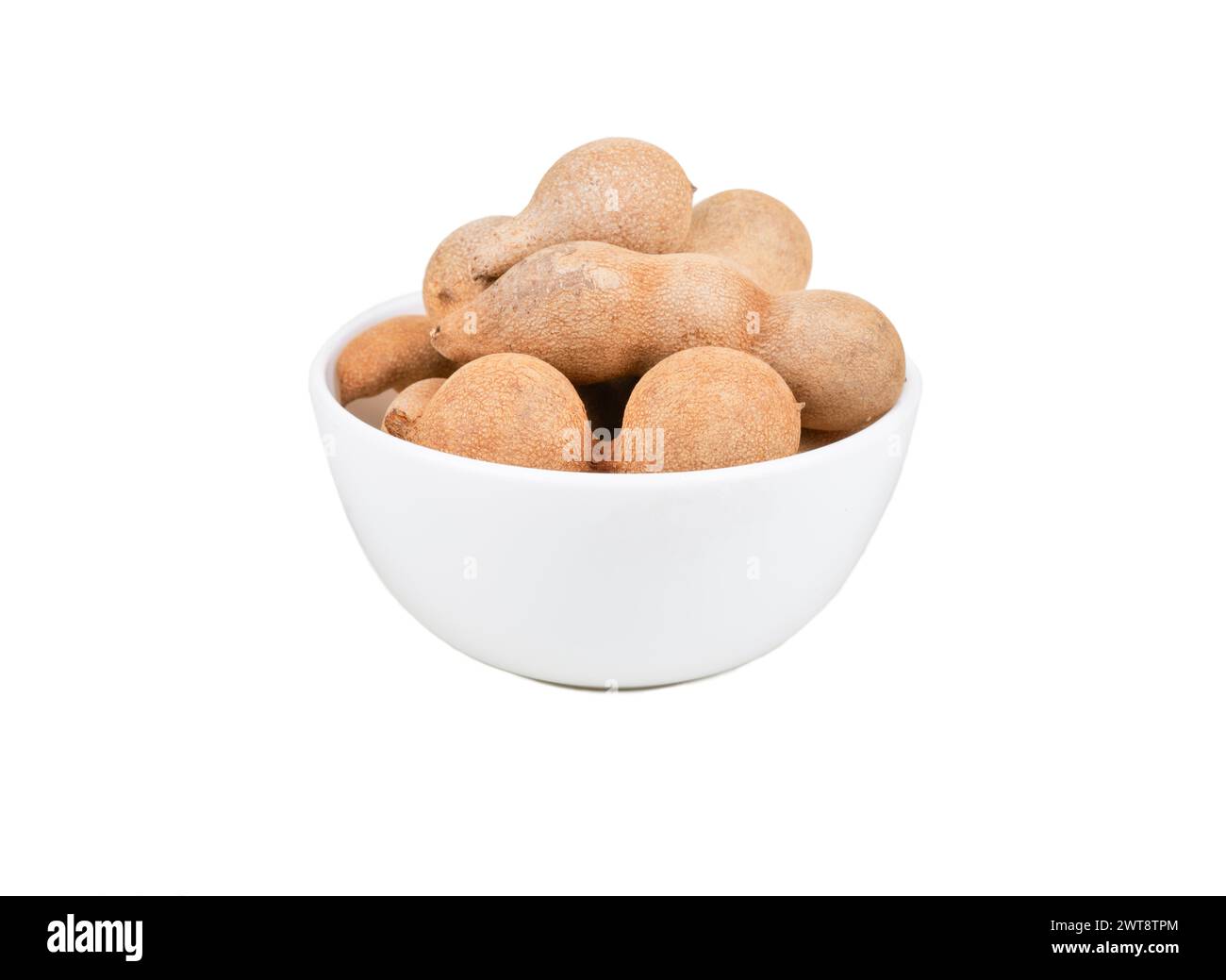 Tamarind fruit in shell and bowl isolated on white background Stock ...