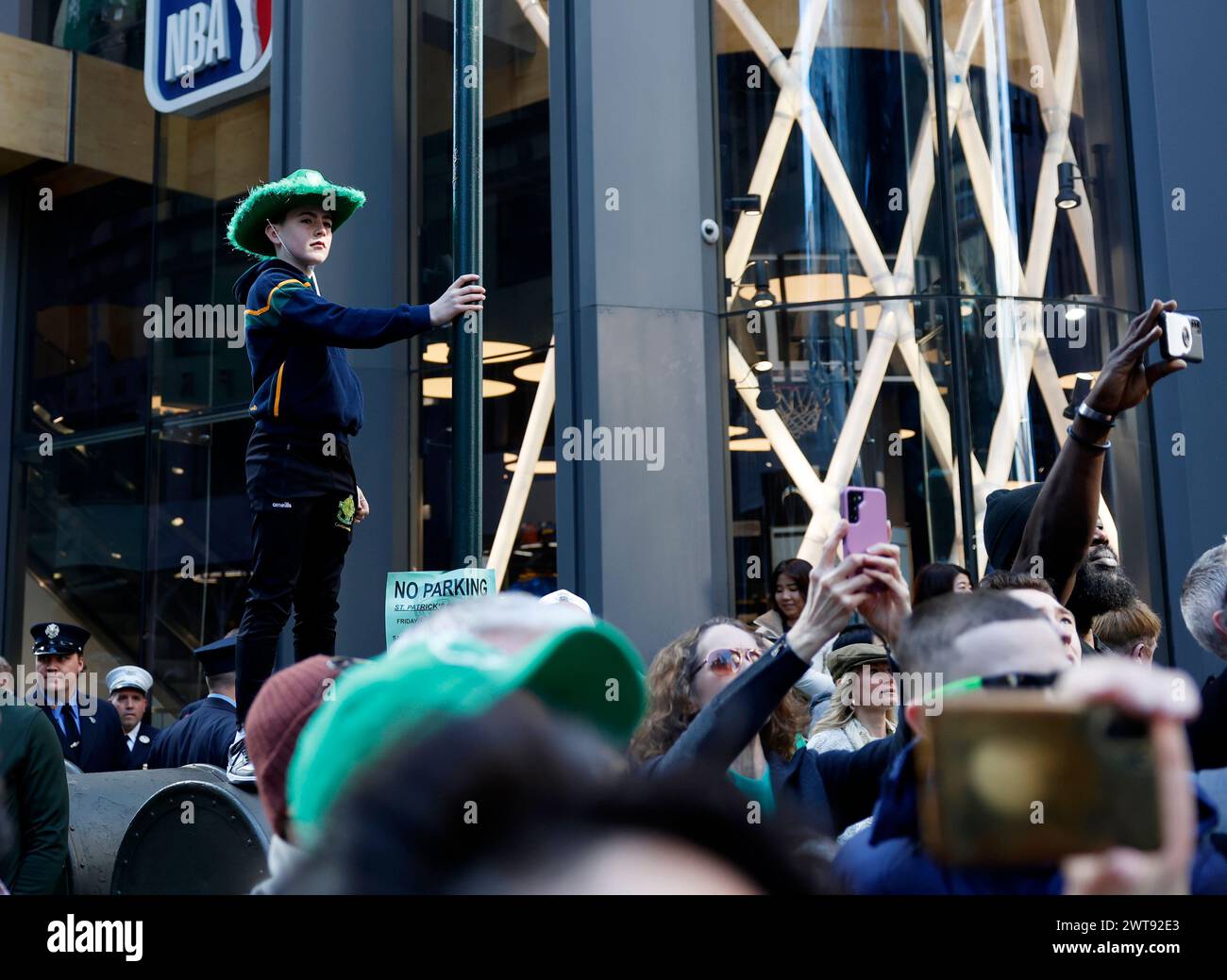 New York, United States. 15th Mar, 2024. Parade goers watch as ...