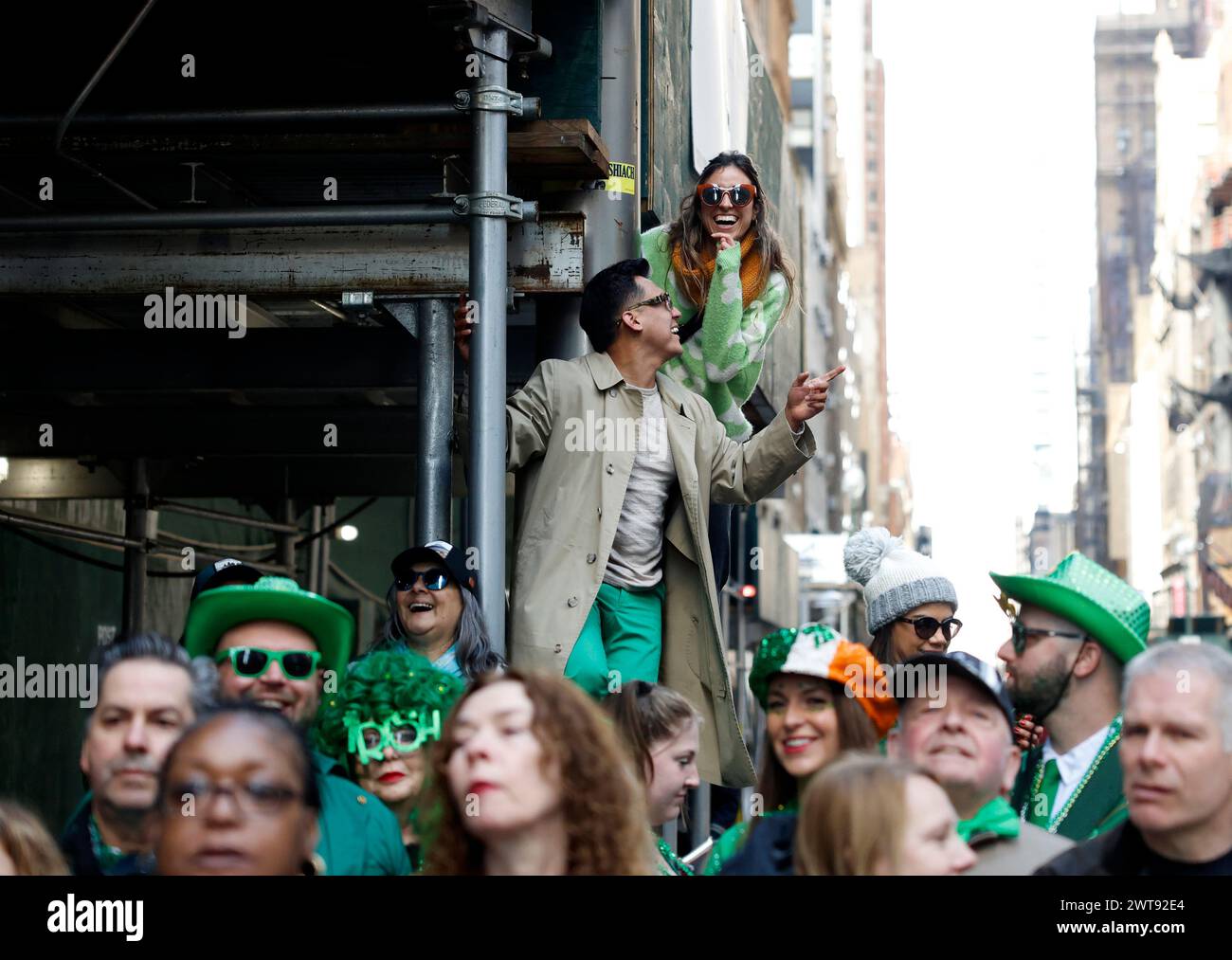 New York, United States. 15th Mar, 2024. Parade goers watch as ...