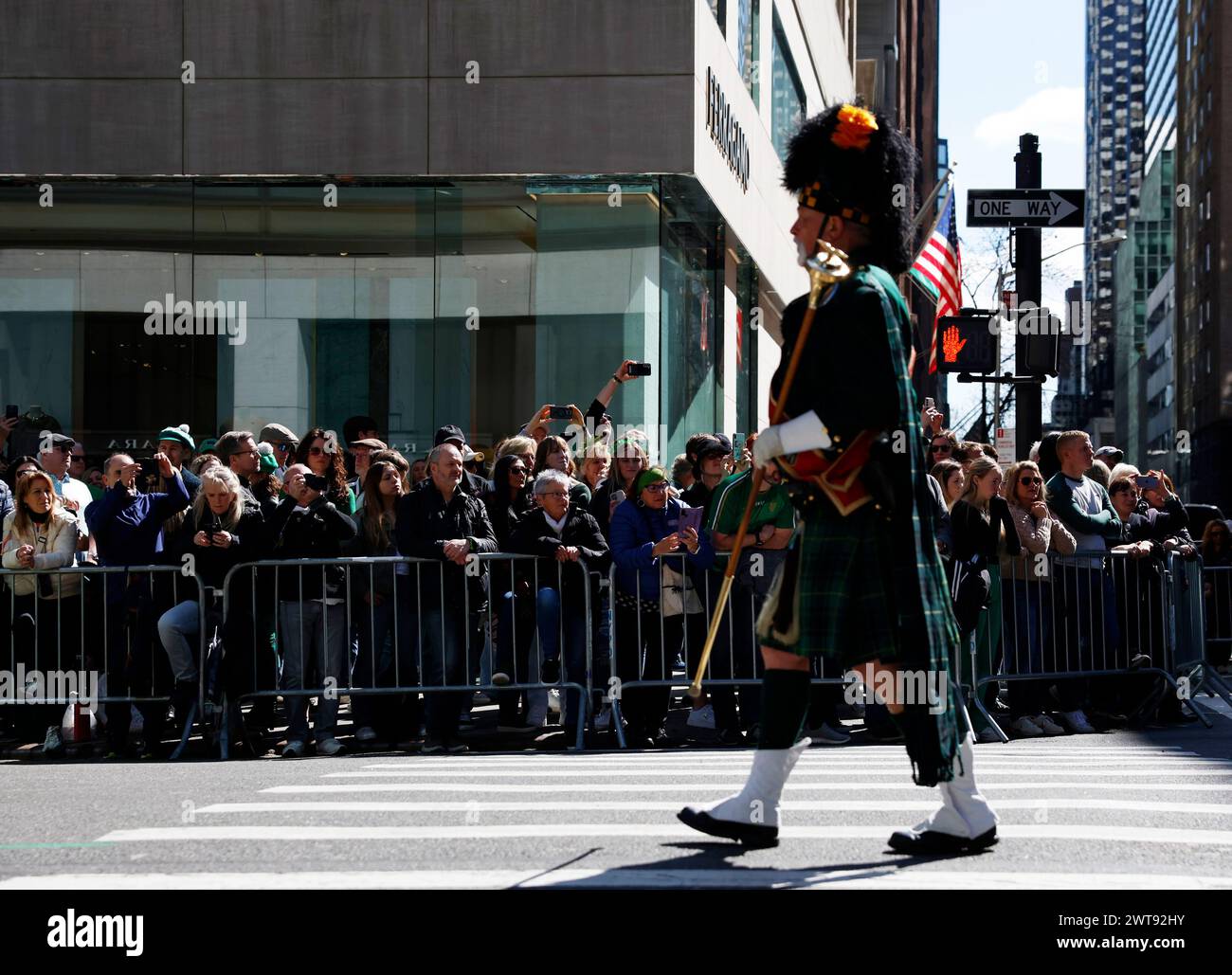 New York, United States. 15th Mar, 2024. Parade goers watch as ...