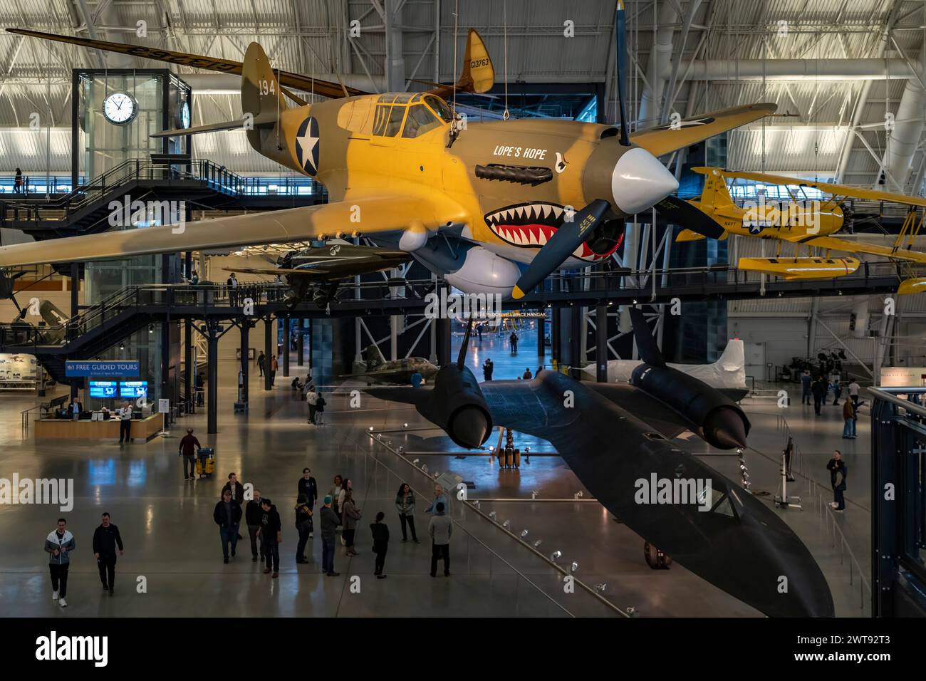 A Curtiss P-40B Warhawk Flying Tiger is suspended from the ceiling at ...