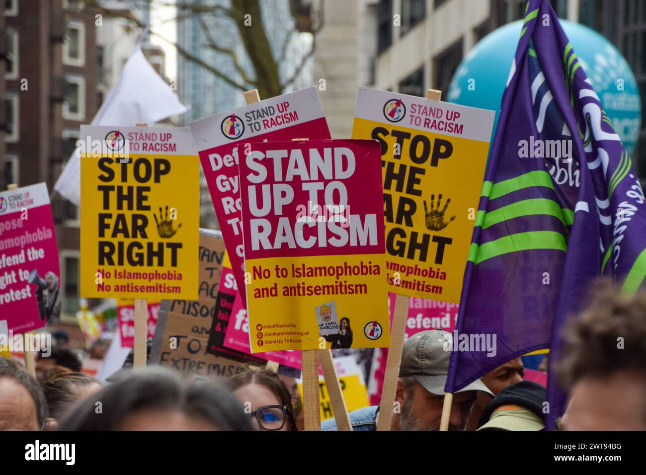 London, UK. 16th Mar, 2024. Protesters hold anti-racism placards ...