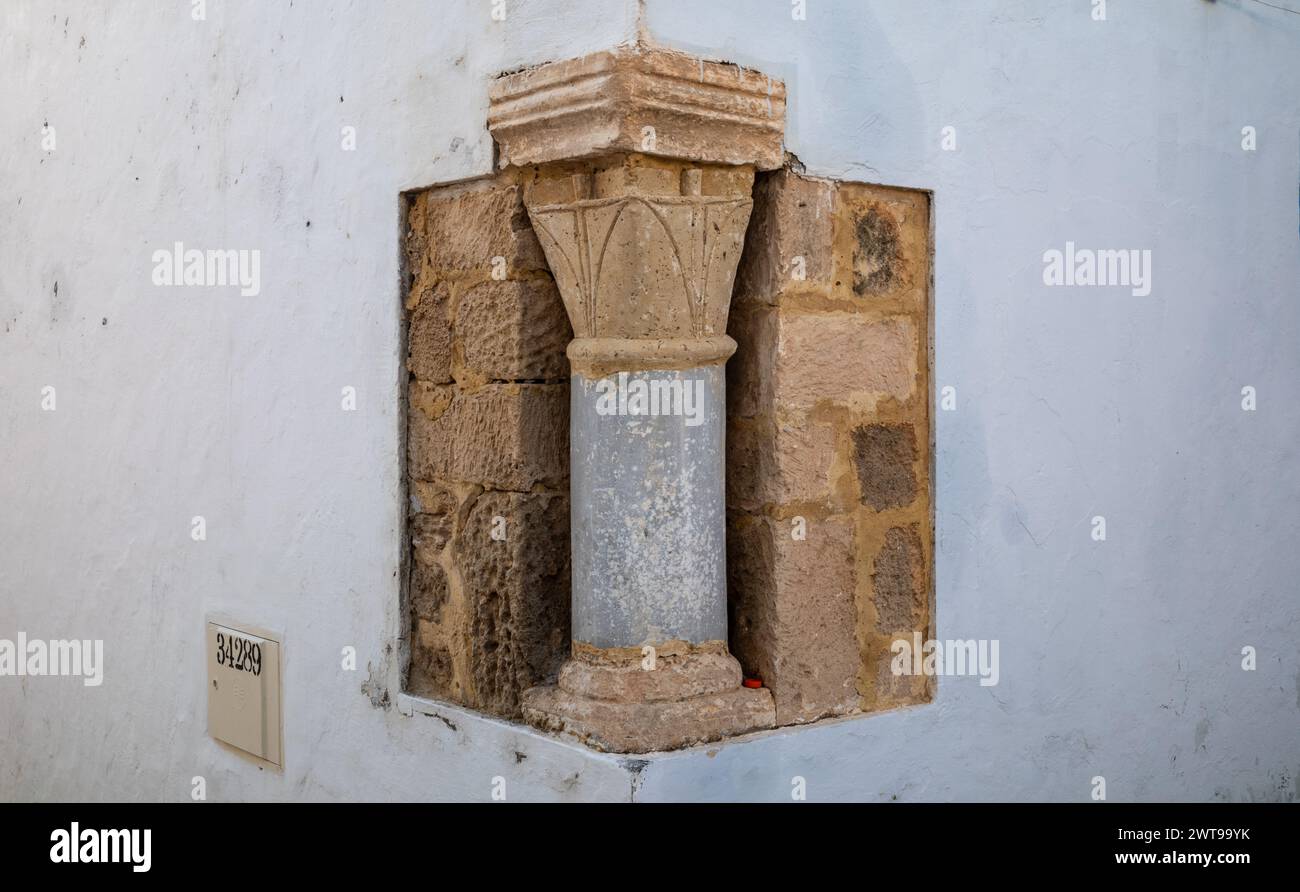 An antique roman column resused in the construction of an ancient ...