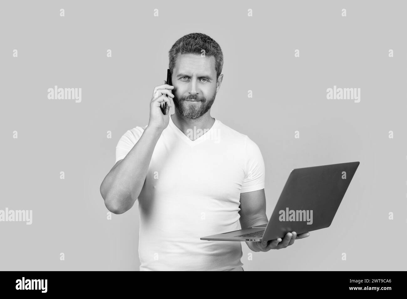 cheerful multitasking freelancing man with phone. multitasking man ...