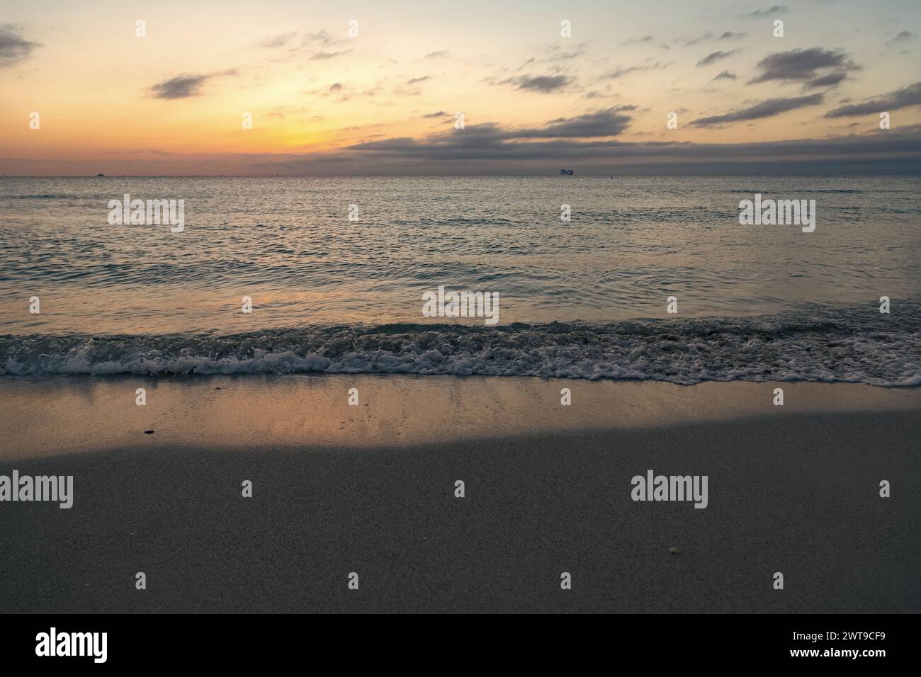 beautiful sundown with sea water on the summer beach Stock Photo - Alamy