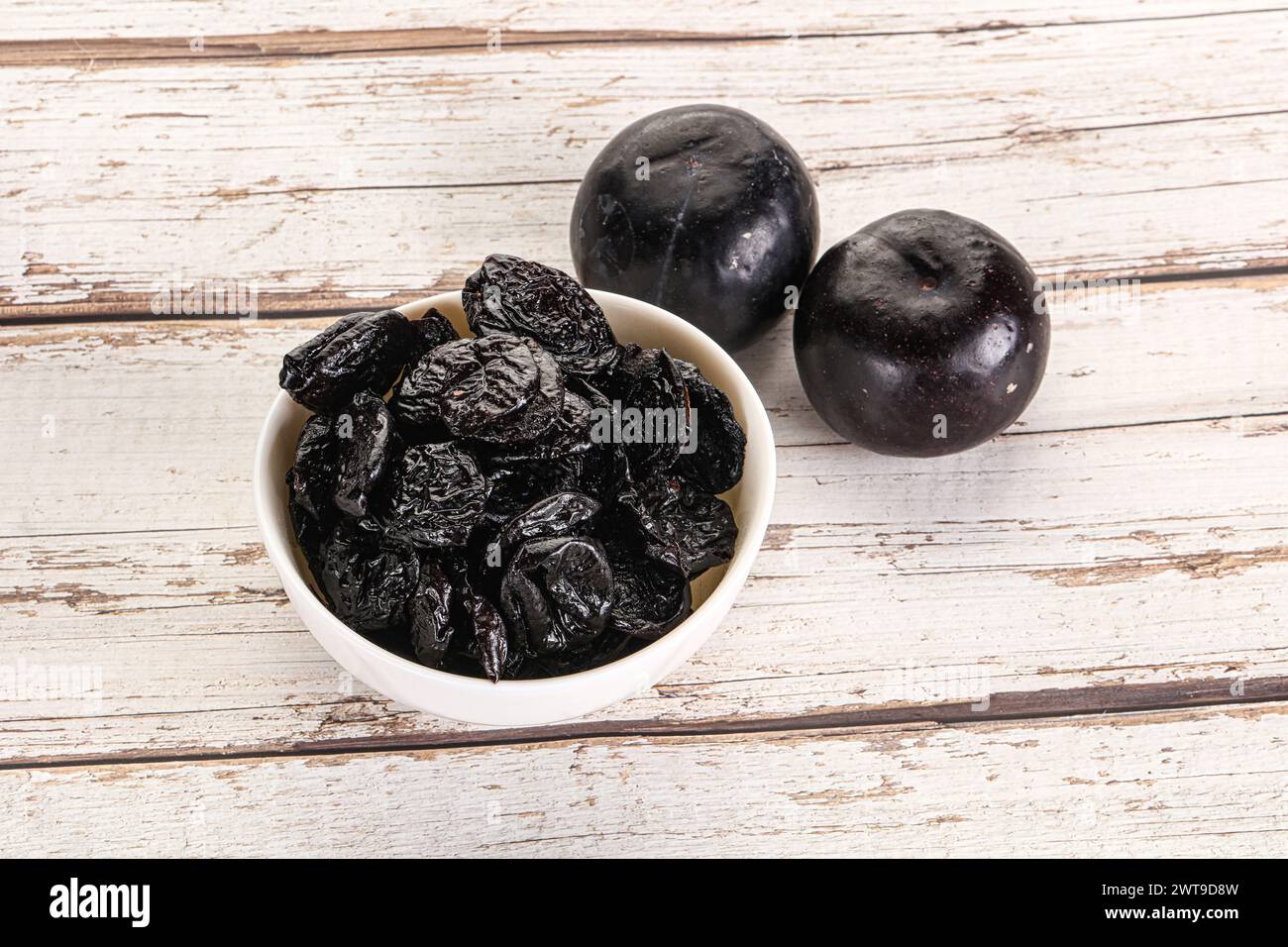 Dry sweet prunes in thw bowl Stock Photo - Alamy