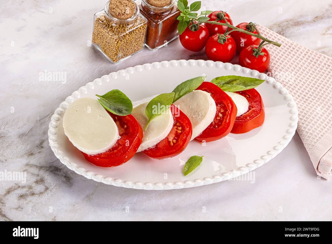 Italian caprese salad with mozzarella, tomato and basil Stock Photo - Alamy