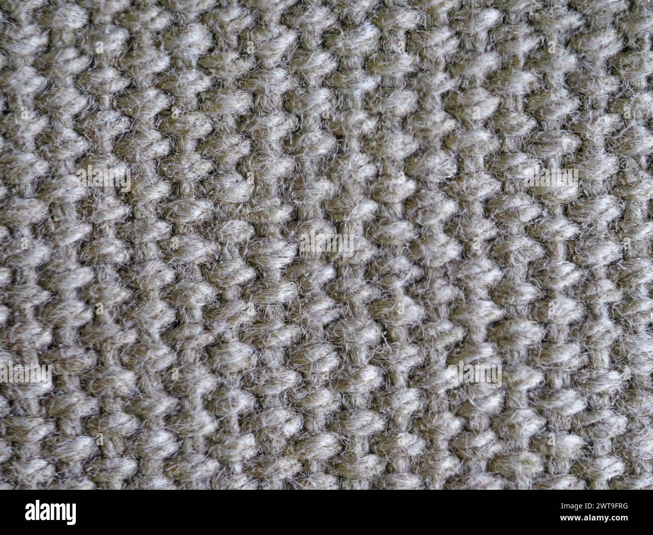 A close up of a fuzzy gray fabric with a lot of texture. The fabric is ...