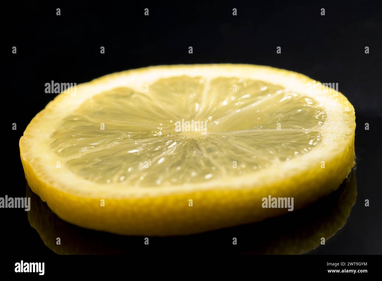Fresh yellow lemon slice with black background and horizontal ...