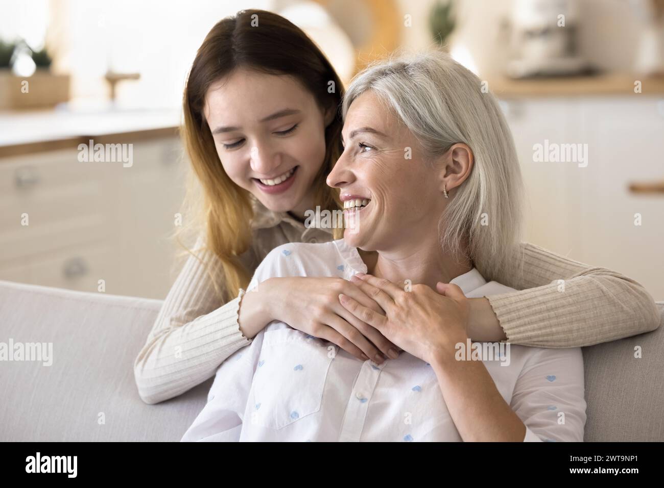 Happy preteen daughter hugging mom with love Stock Photo - Alamy