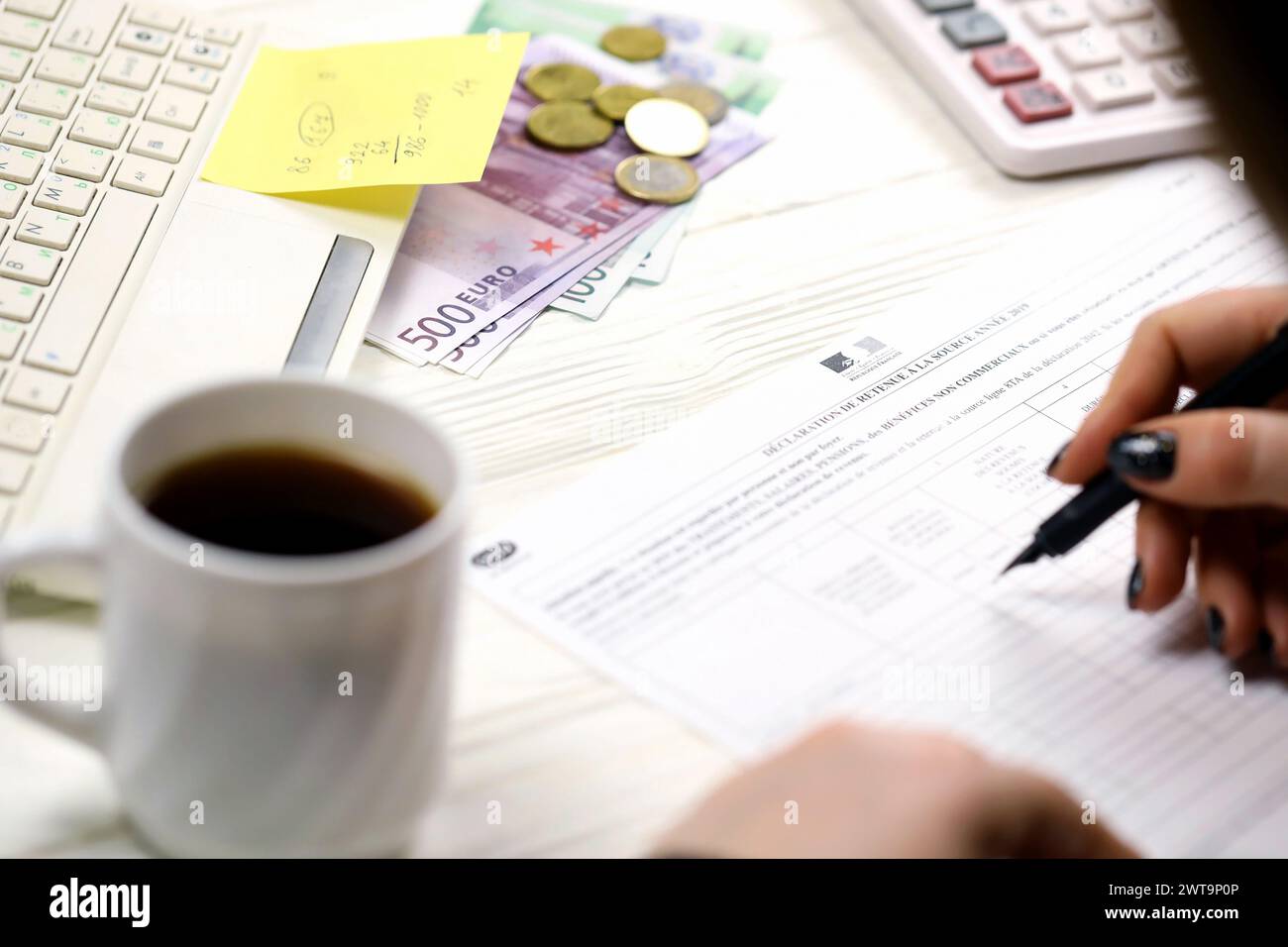 KYIV, UKRAINE - OCTOBER 31, 2023 Accountant fill french tax form 2041E ...