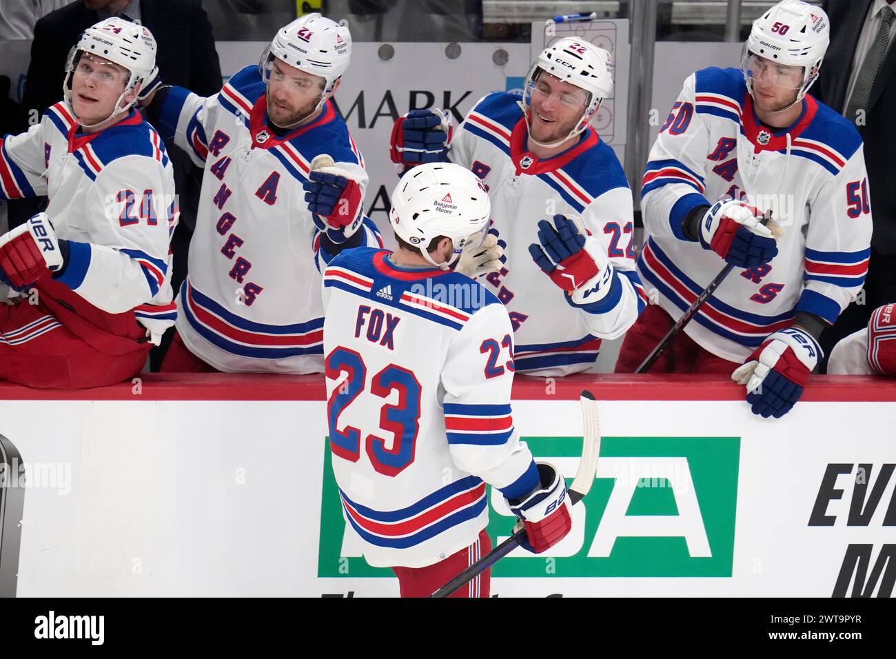 New York Rangers' Adam Fox (23) returns to his bench after scoring ...