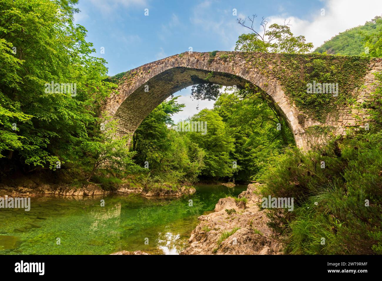 Old bridge over the Dobra river, dating from the Middle Ages and built ...