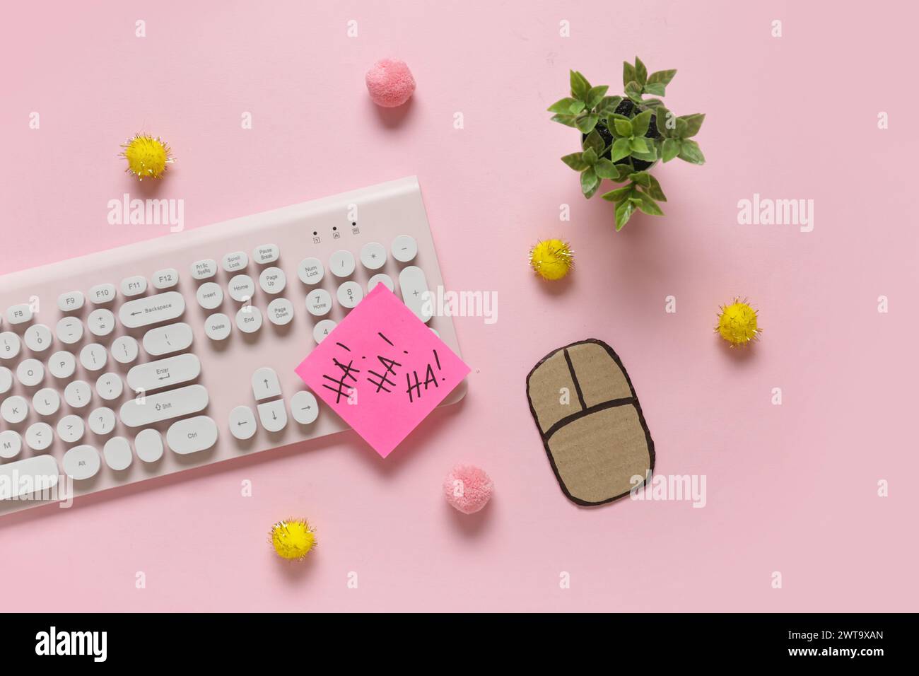 Computer keyboard with carton mouse, sticky note and decor on pink ...