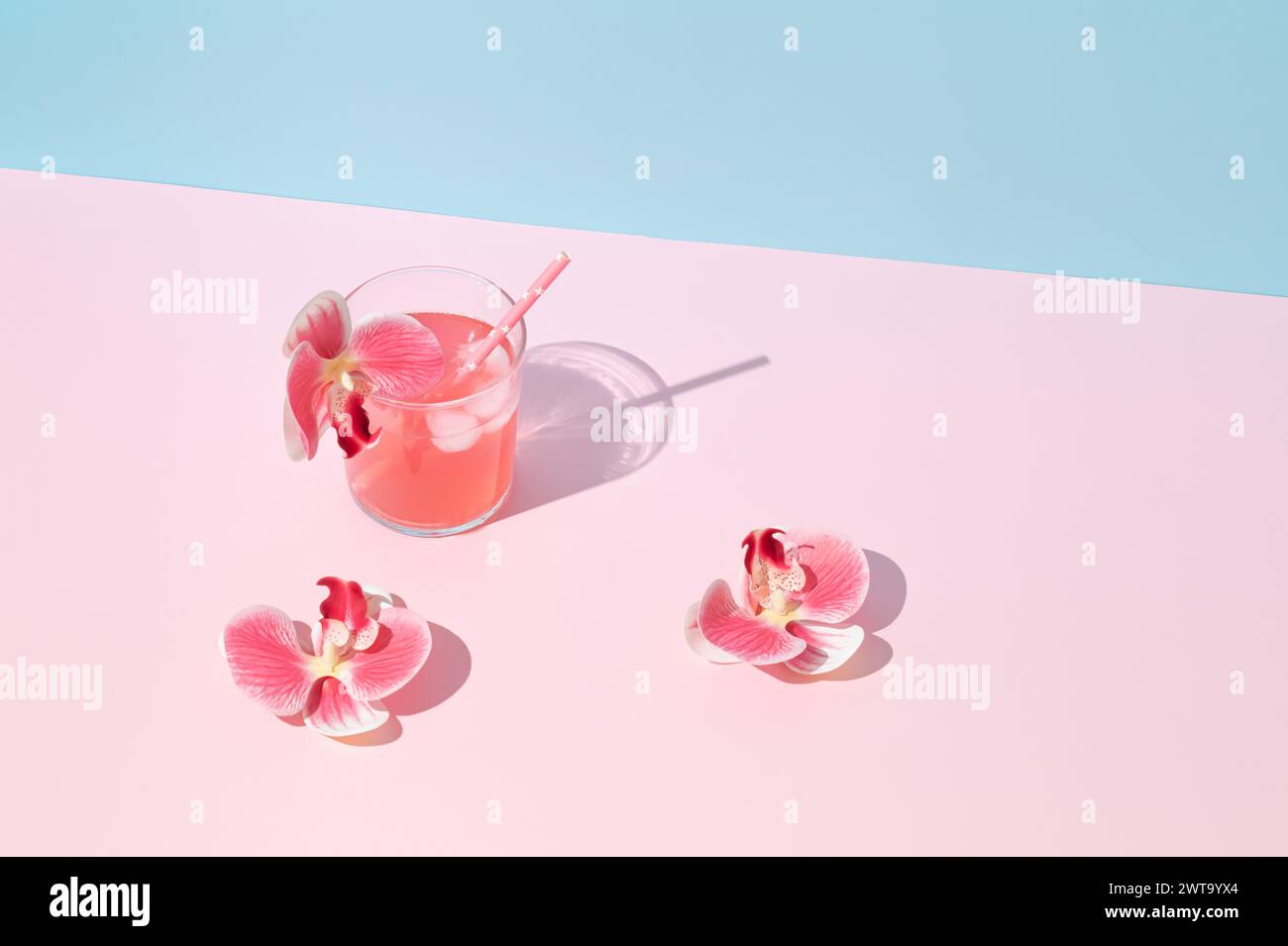 Summer scene made with pink tropical refreshing drink and orchid ...