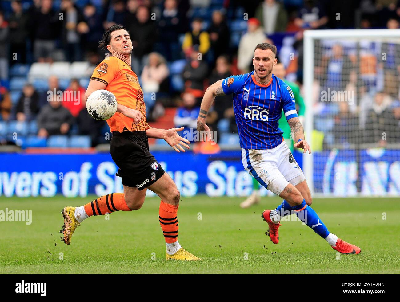 Joe Quigley of Chesterfield Football Club is tussling with Liam Hogan ...