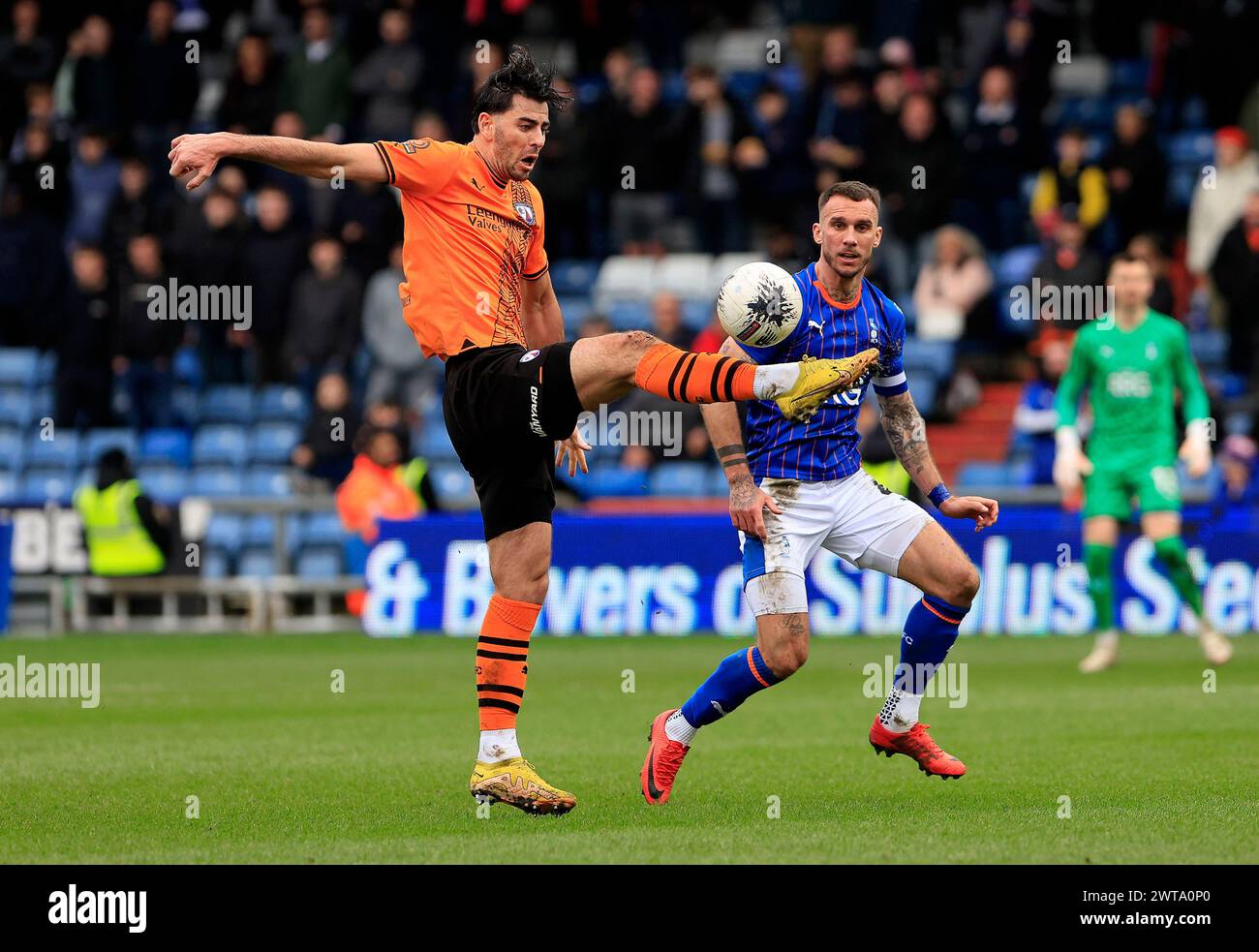Joe Quigley of Chesterfield Football Club is tussling with Liam Hogan ...