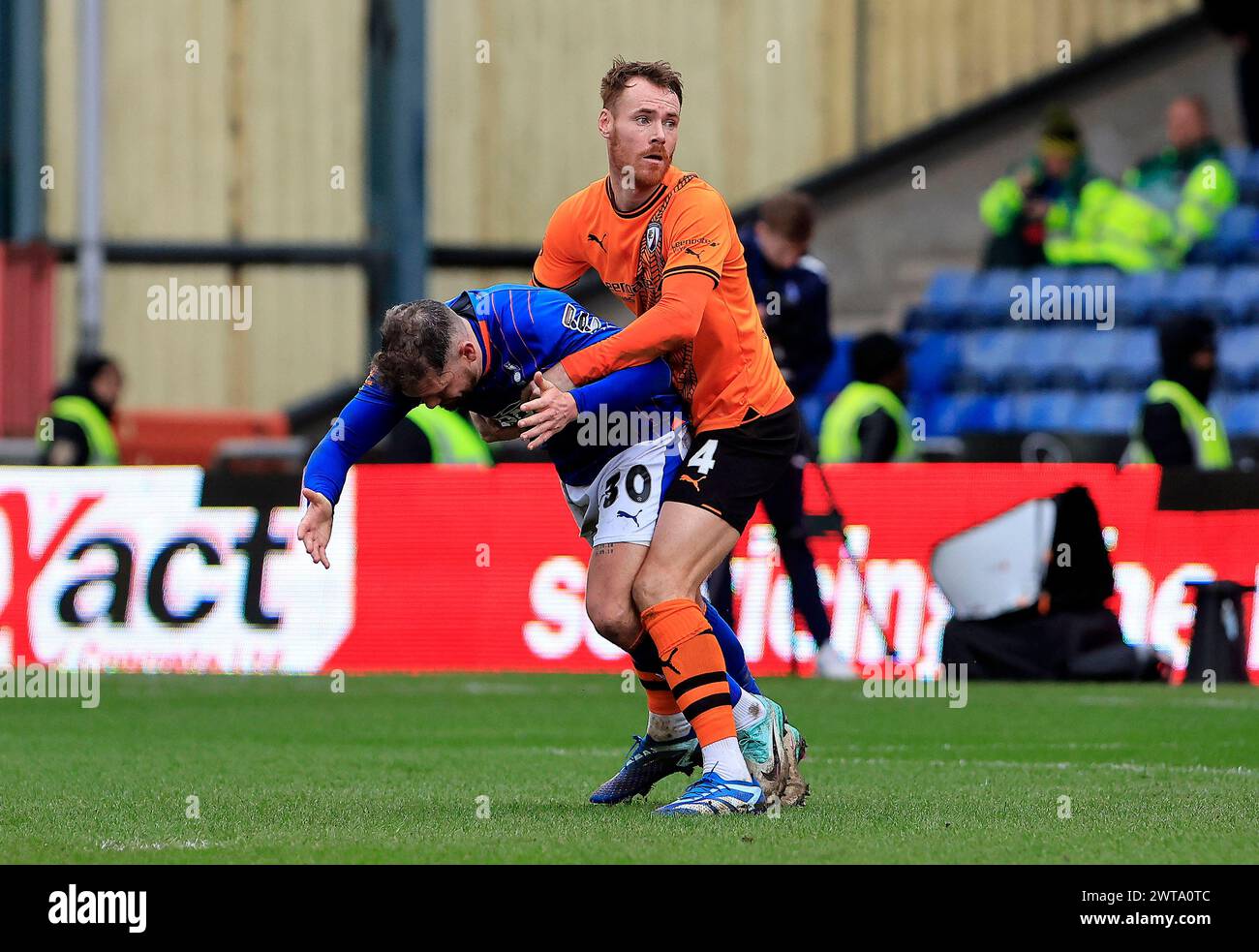 James Norwood of Oldham Athletic Association Football Club is held up ...
