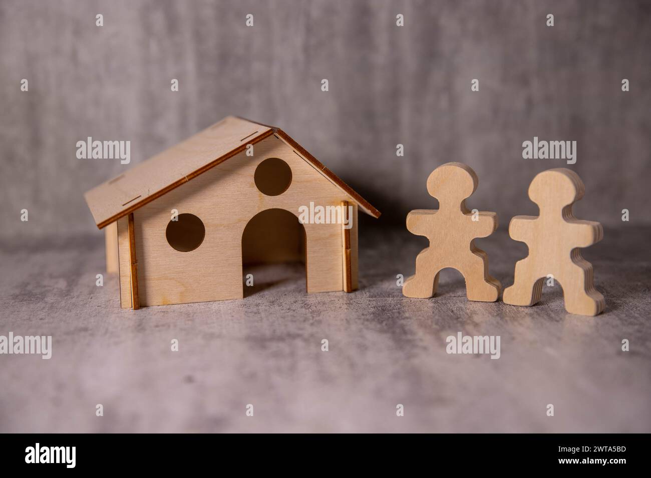 Wooden figures of houses and a poster with green arrow up. Increase ...