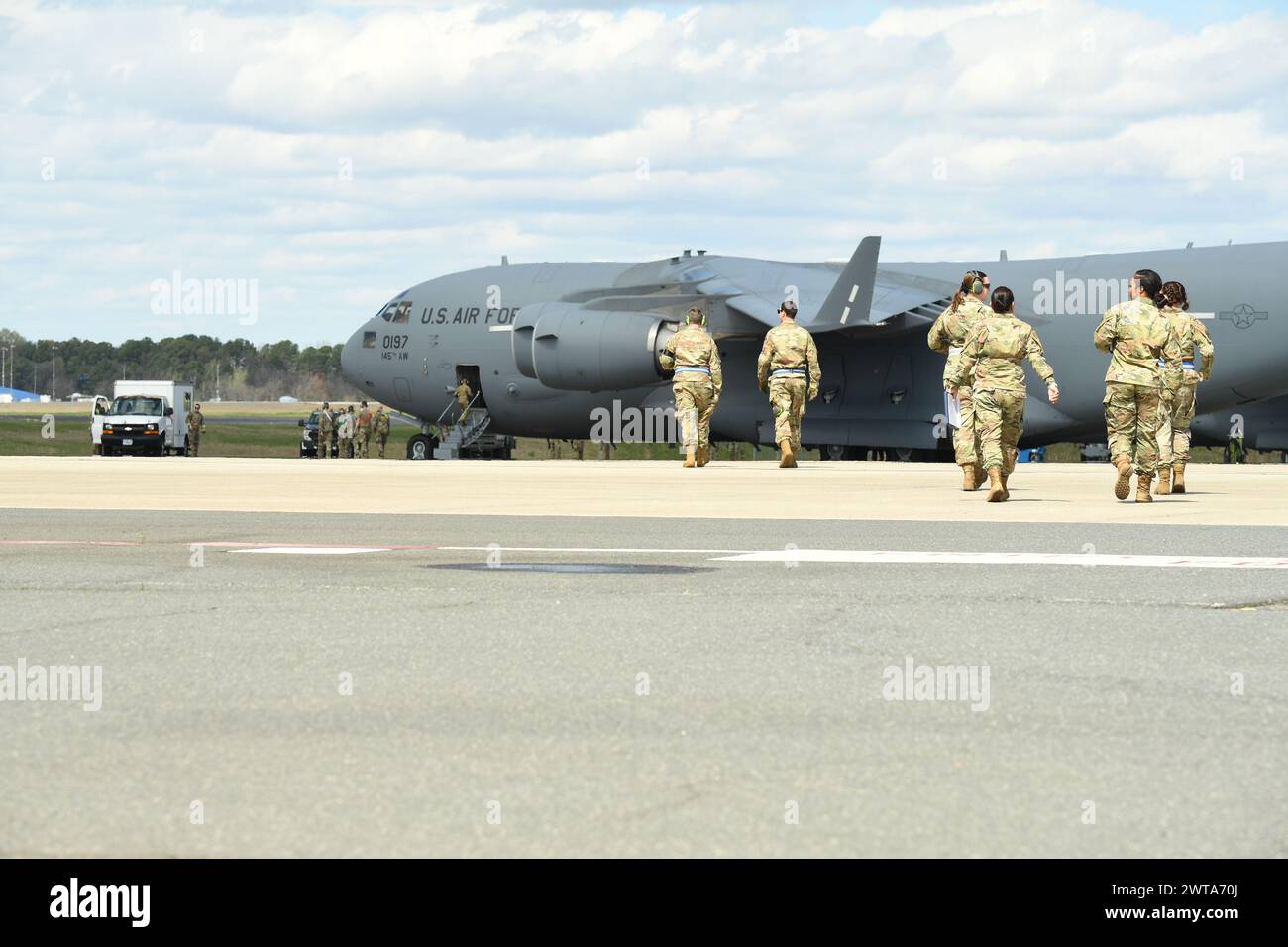 North Carolina Air National Guardsmen approach a recently parked C-17 ...