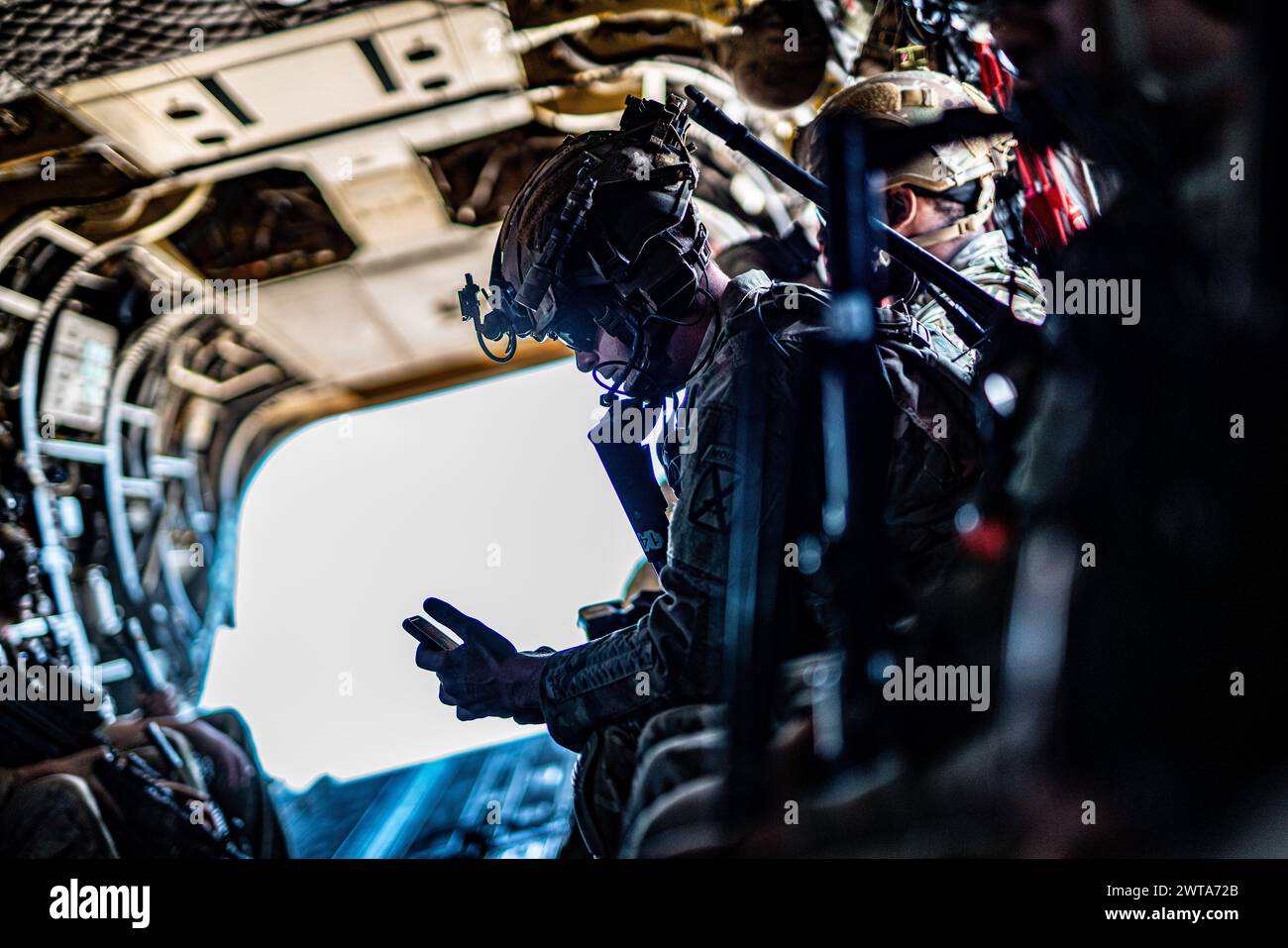 U.S. Army Soldiers assigned to the 10th Mountain Division board a CH-47 ...
