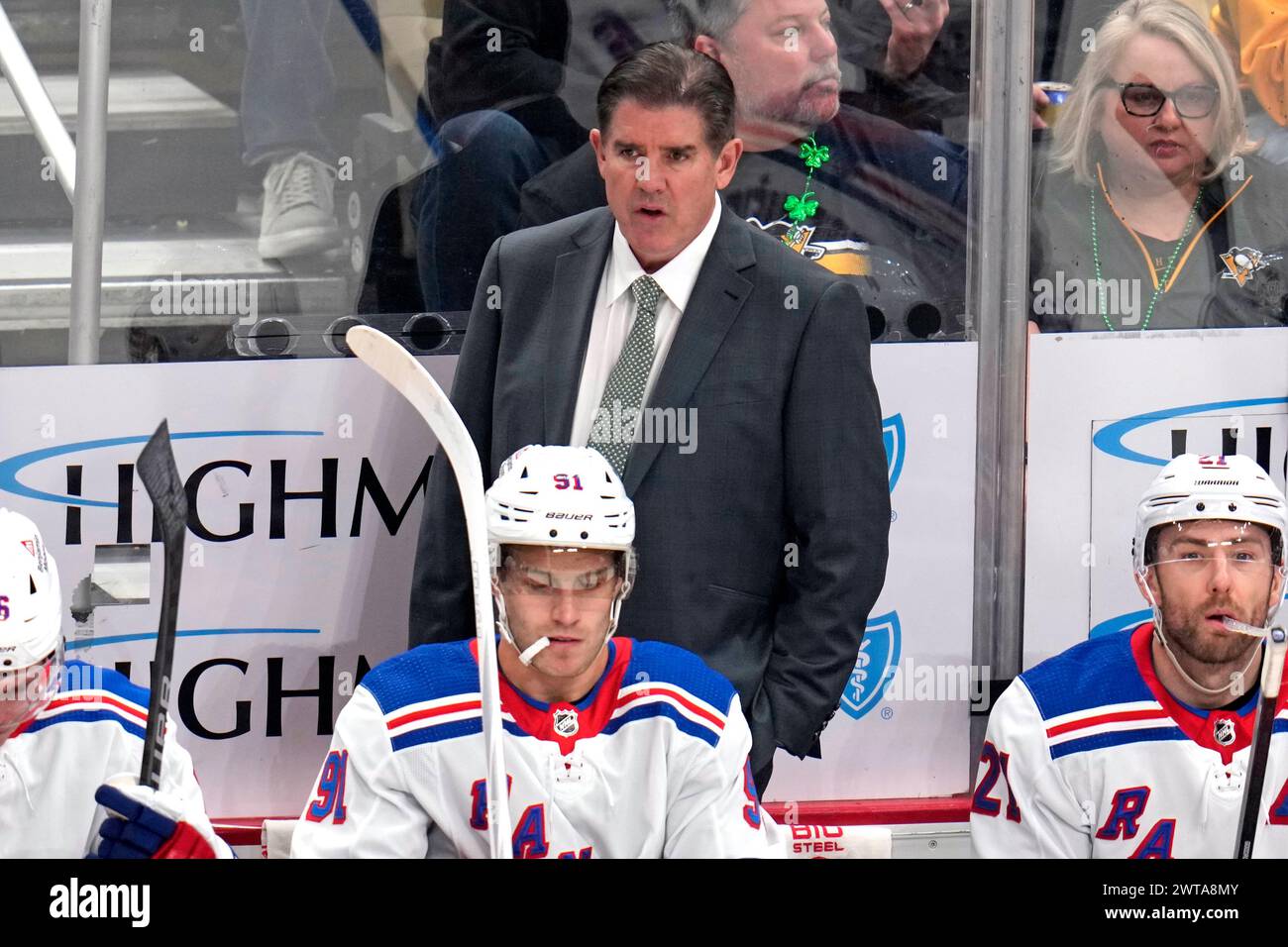 New York Rangers head coach Peter Laviolette stands behind his bench during the first period of ...