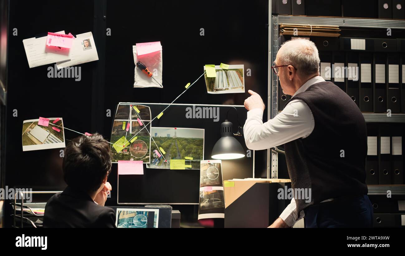 Two investigators review evidence and incriminating proof to find ...