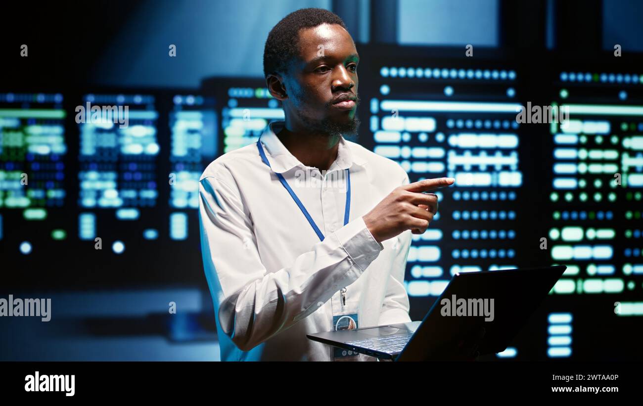 System administrator ensuring data center servers are properly equipped ...