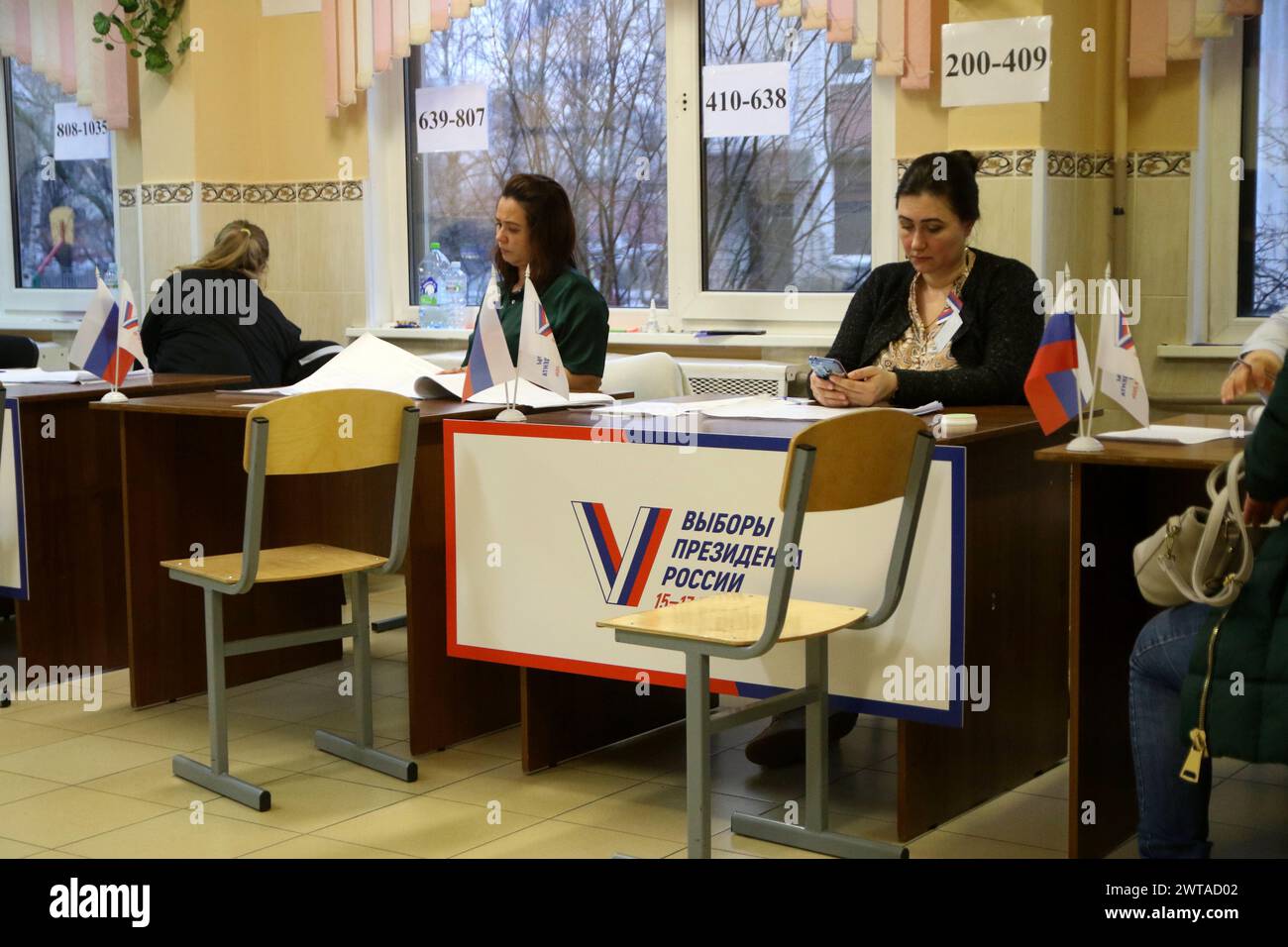 Polling officials wait for voters at the polling station during the ...