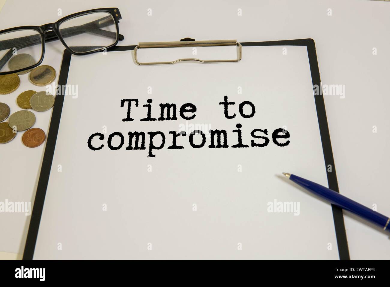 TIME TO COMPROMISE text on paper with keyboard, calculator on grey ...