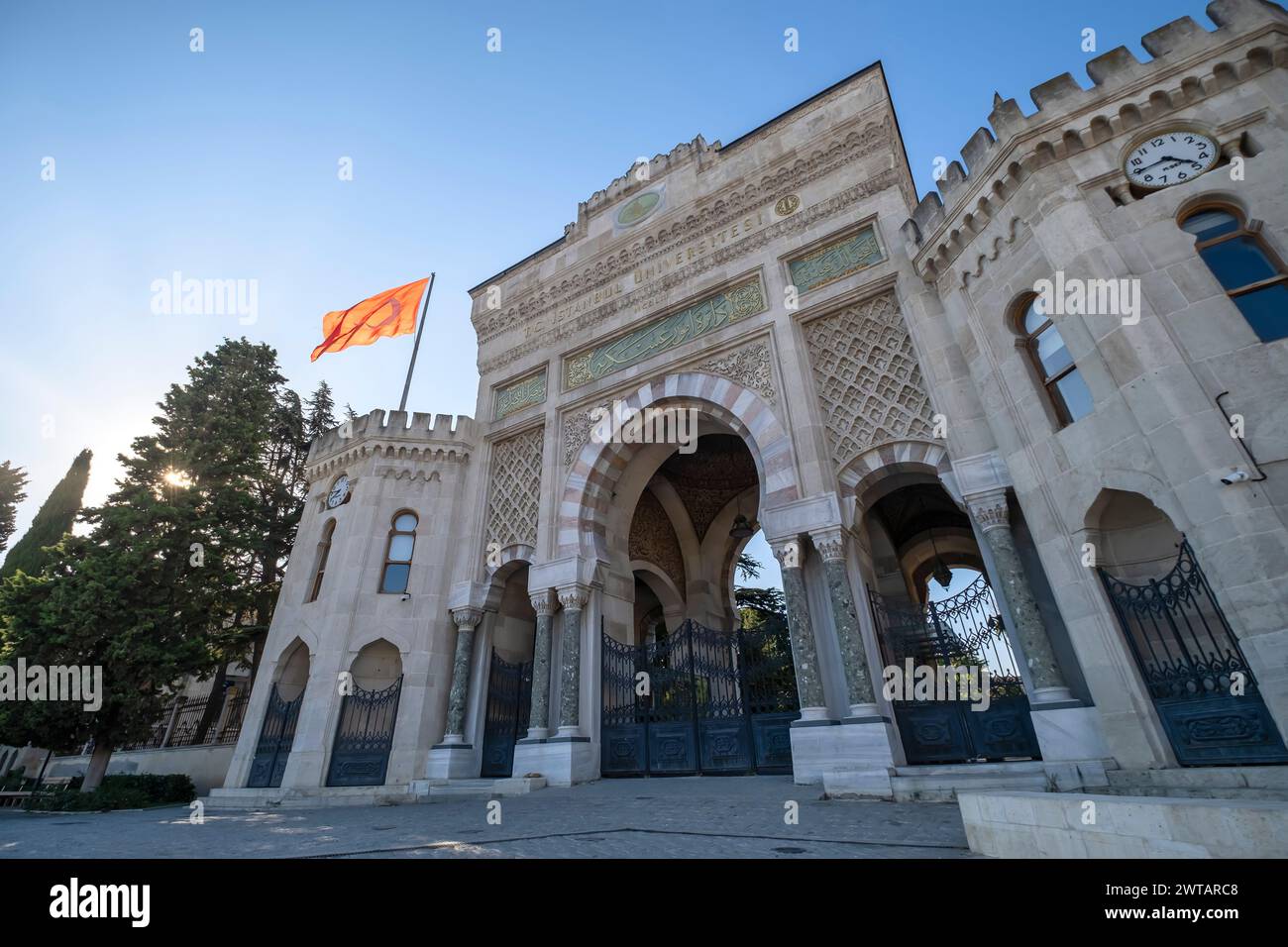 main entrance of the university of istanbul with the waving flag of ...