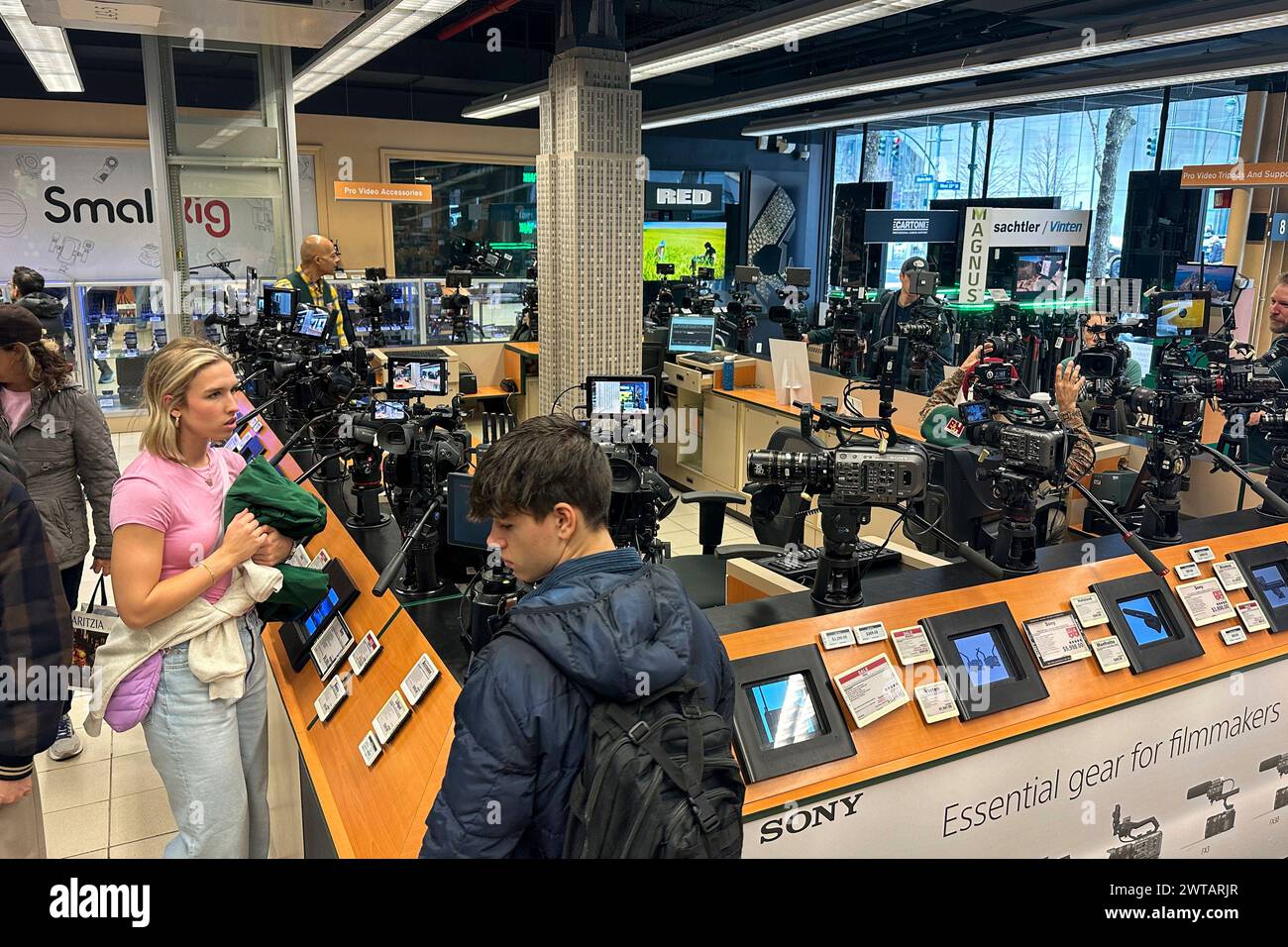 People shop for professional video cameras at the B&H Photo Video store ...
