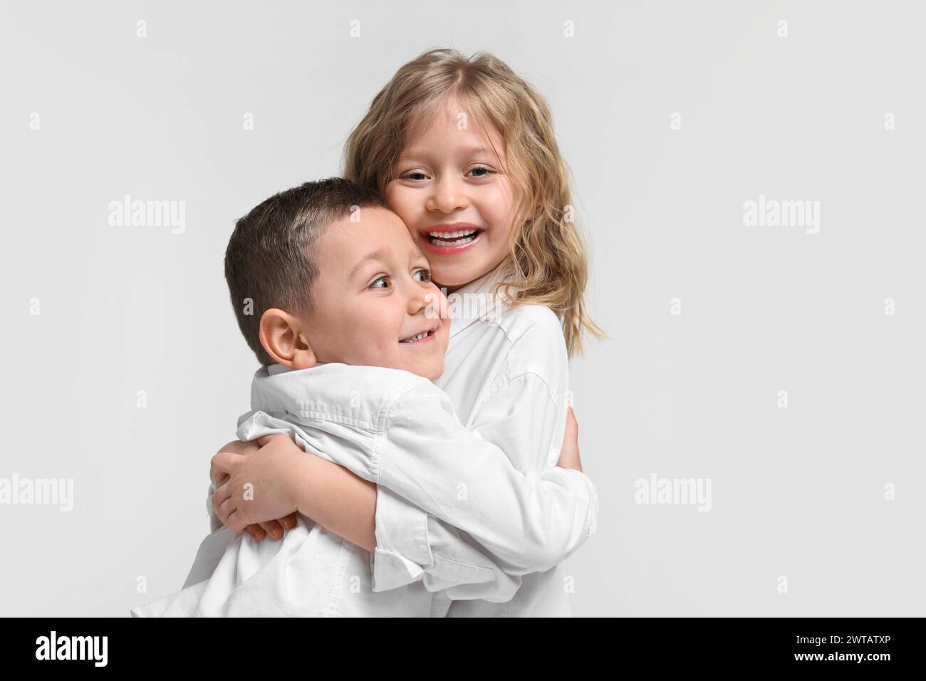 Cute little children hugging on white background. Happy family Stock ...