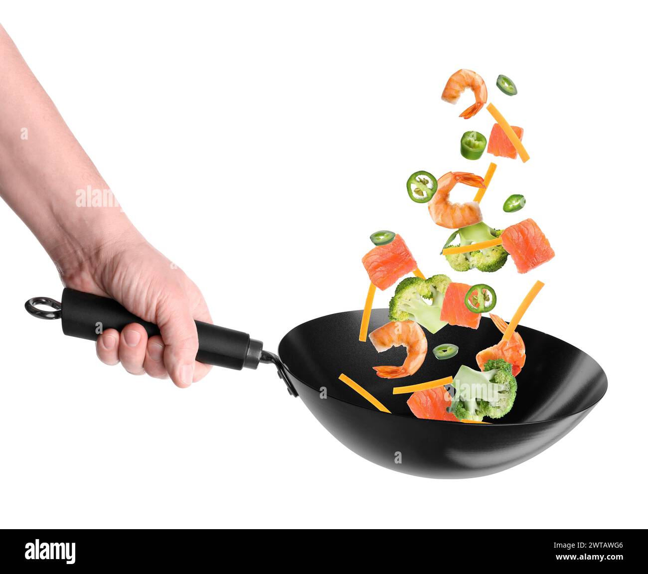 Hand tossing broccoli in metal hi-res stock photography and images - Alamy