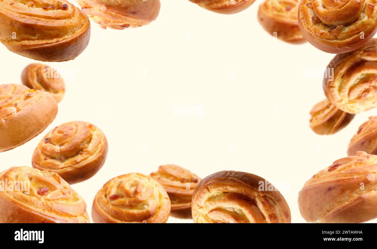 Sweet buns. Delicious rolls with raisins falling on beige background ...