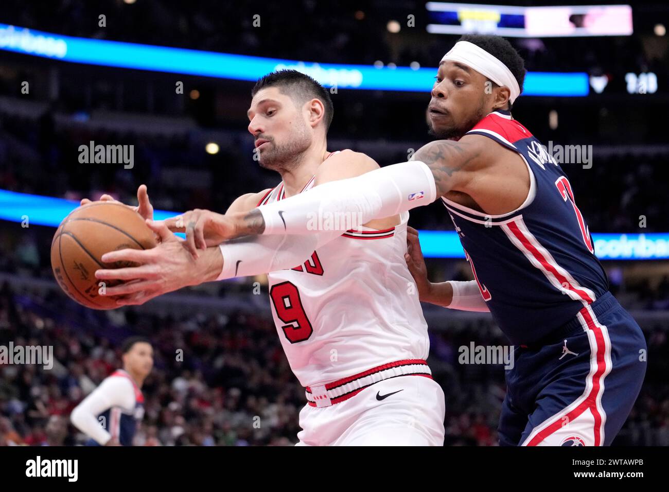 Chicago Bulls' Nikola Vucevic (9) and Washington Wizards' Richaun Holmes, right, battle for a ...