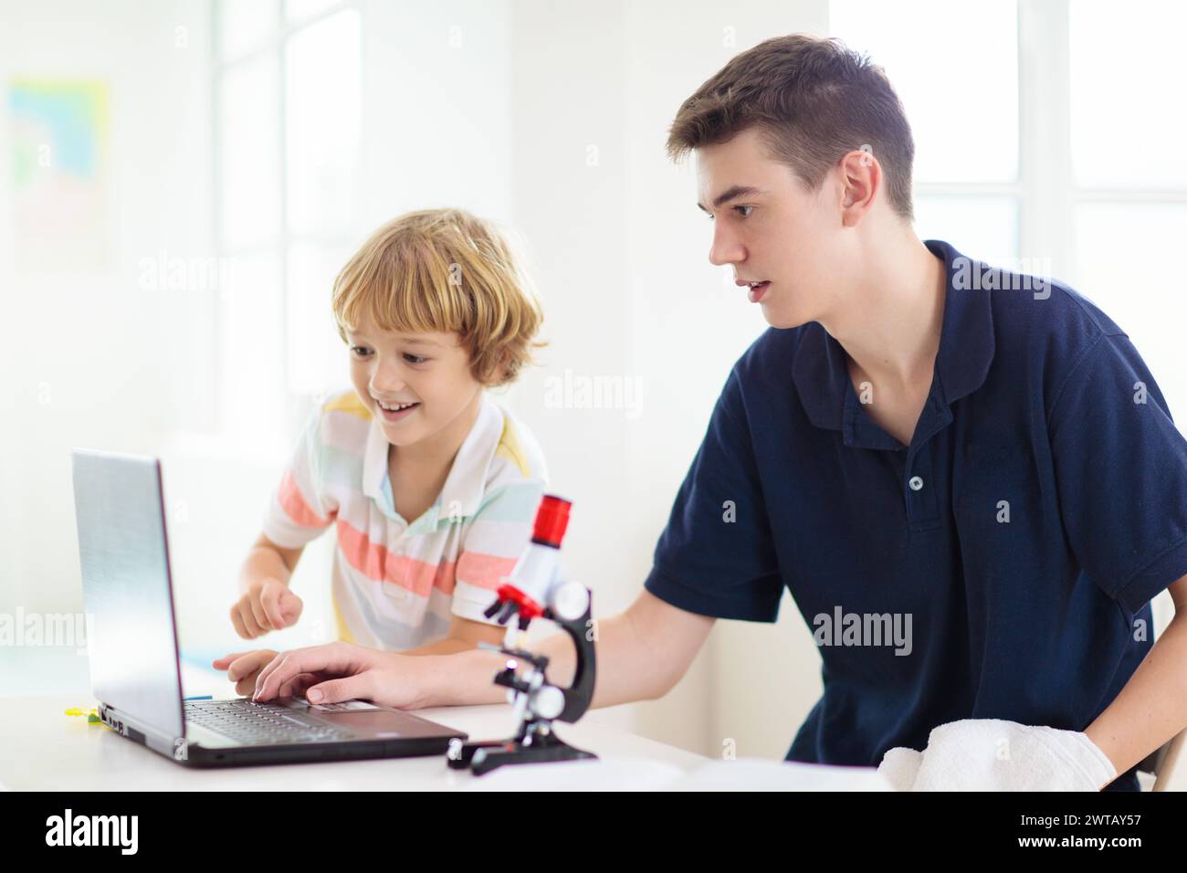 School kids with microscope. Science class. Children making biology or ...