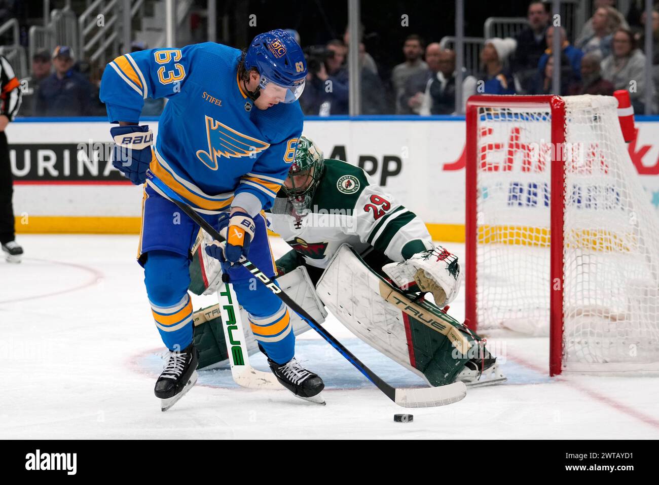 St. Louis Blues' Jake Neighbours (63) controls the puck as Minnesota ...