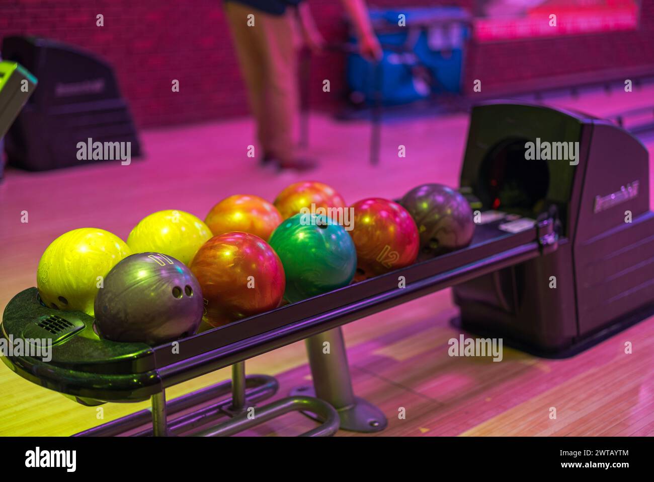 Close-up view of a bowling alley ball dispenser Stock Photo - Alamy