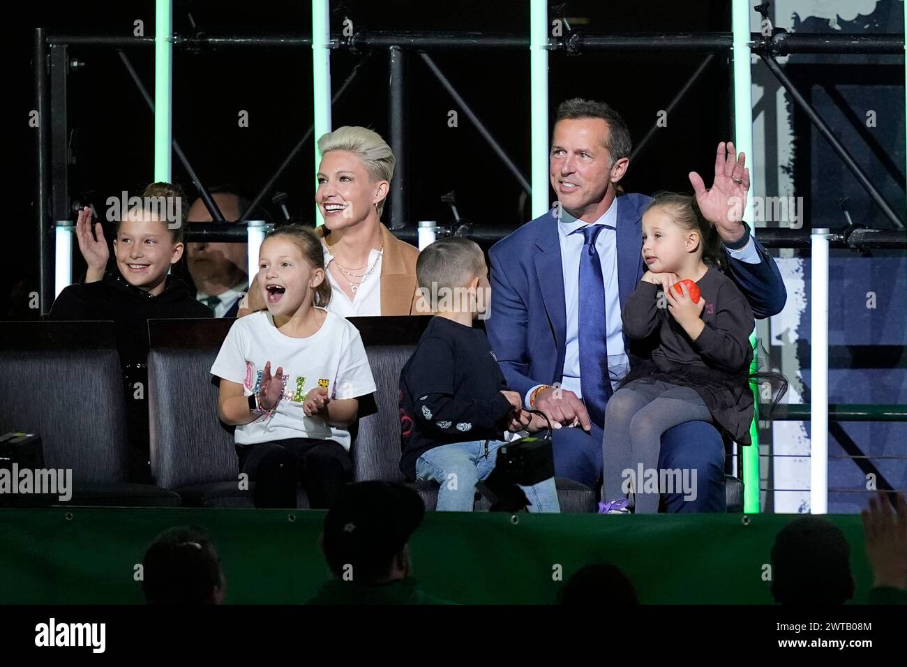 Former Dallas Stars Mike Modano waves with his family before the ...