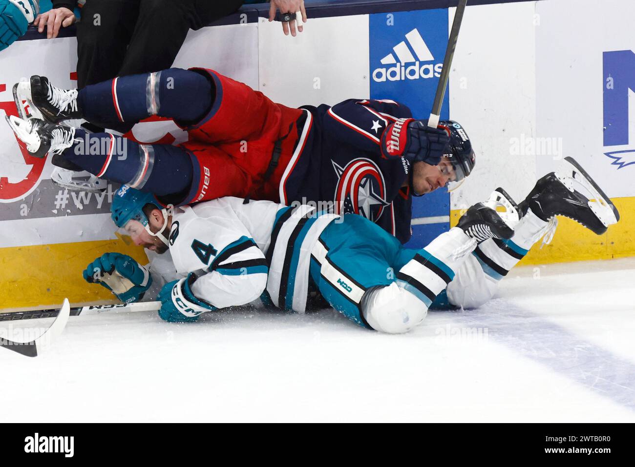 San Jose Sharks defenseman Kyle Burroughs (4) collides with Columbus ...