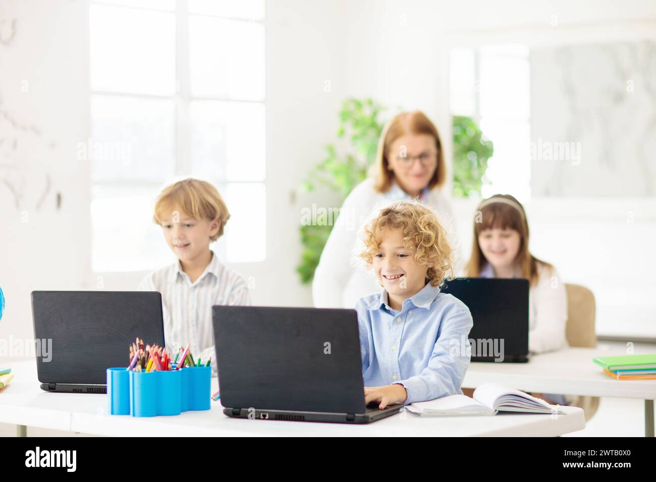 School children with laptop computer. Video conference chat with ...