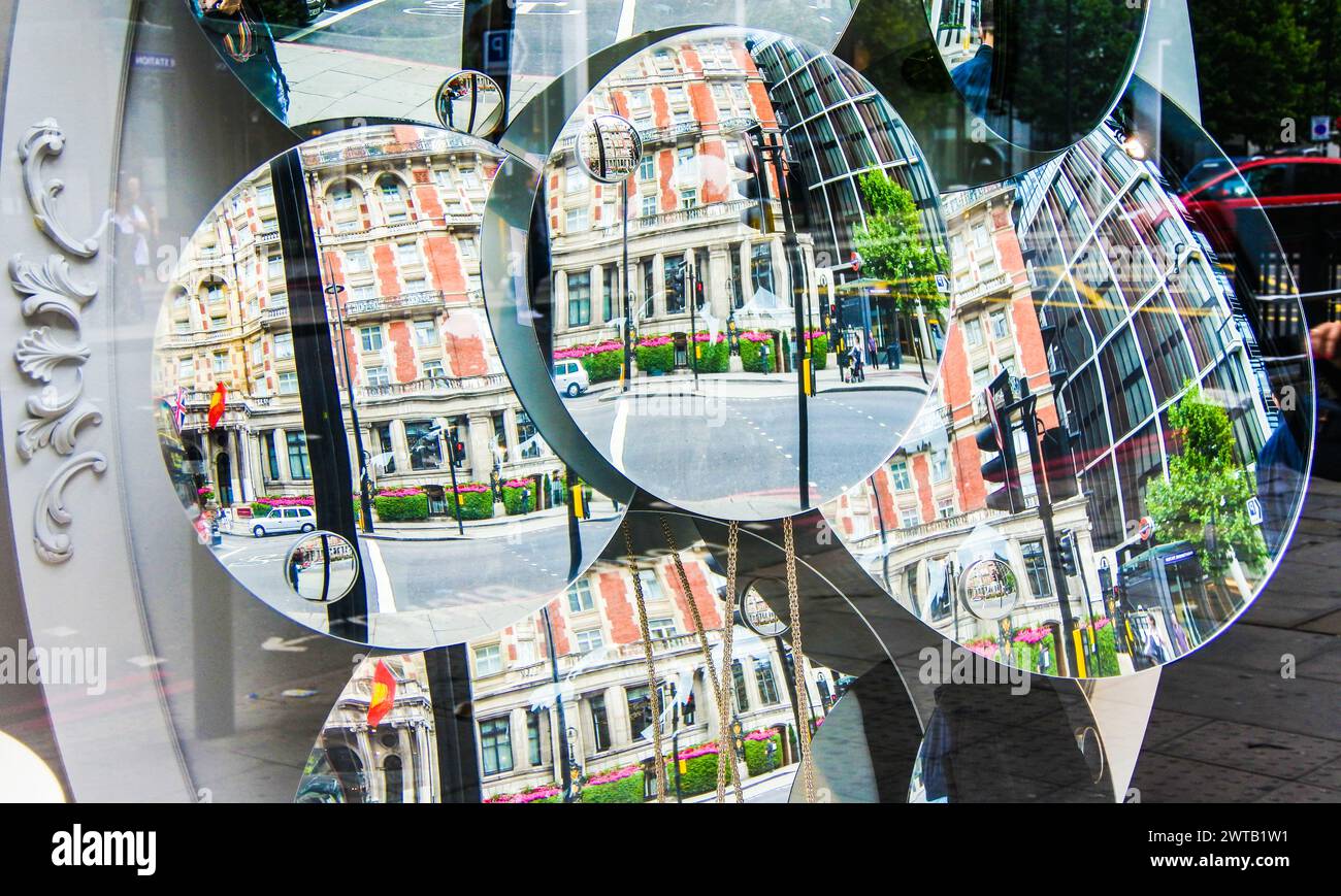 Reflections of Piccadilly Street buildings in shop window display of ...