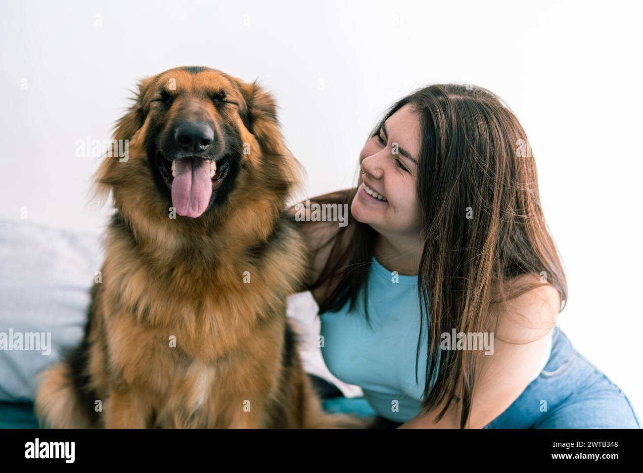 A cheerful Latina woman shares a playful and affectionate moment with ...