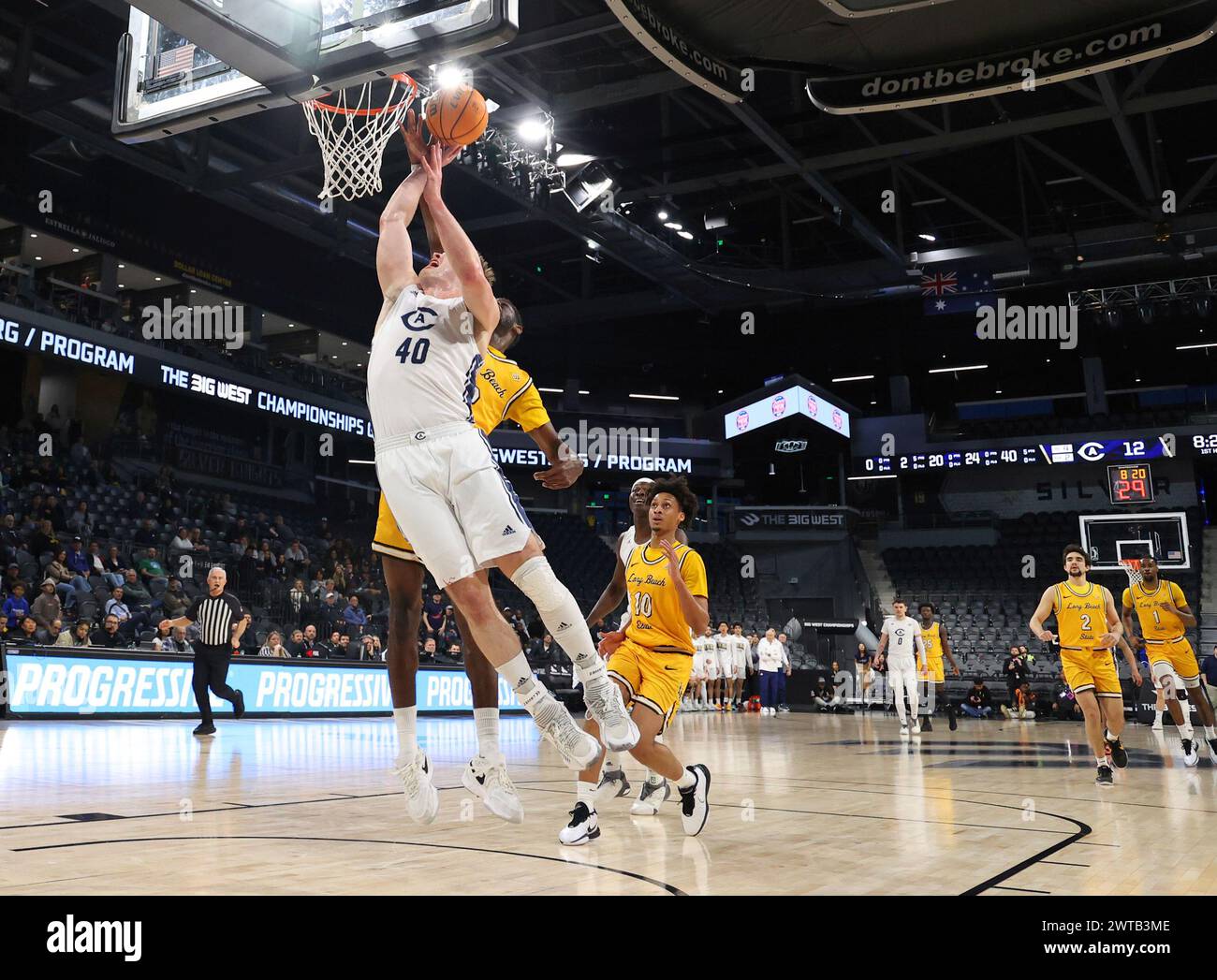 UC Davis guard Elijah Pepper (40) gets tangled with Long Beach State ...