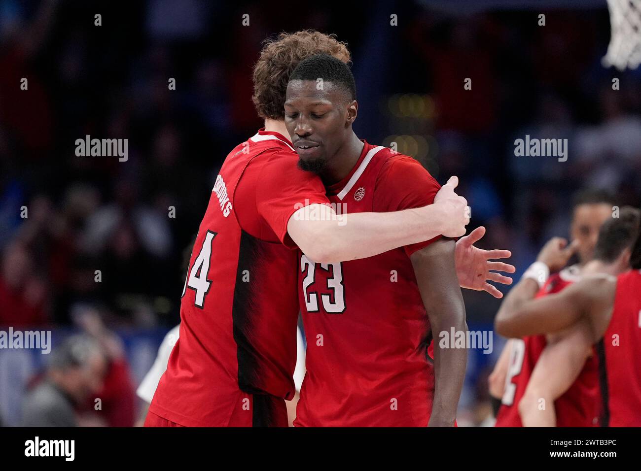 North Carolina State forward Mohamed Diarra (23) is hugged by North ...